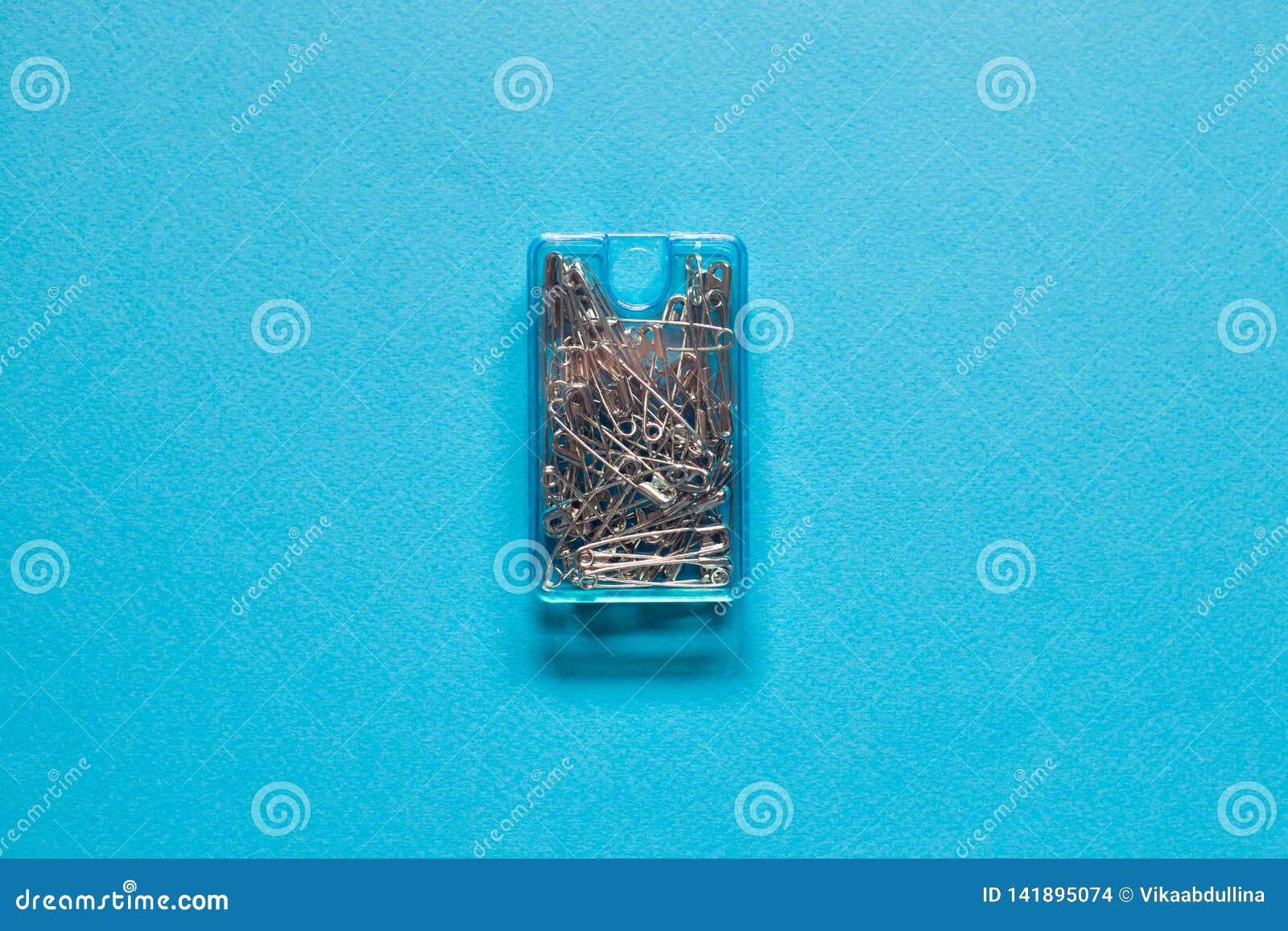 Safety Pins in Blue Plastic Box on Blue Background Stock Photo - Image ...