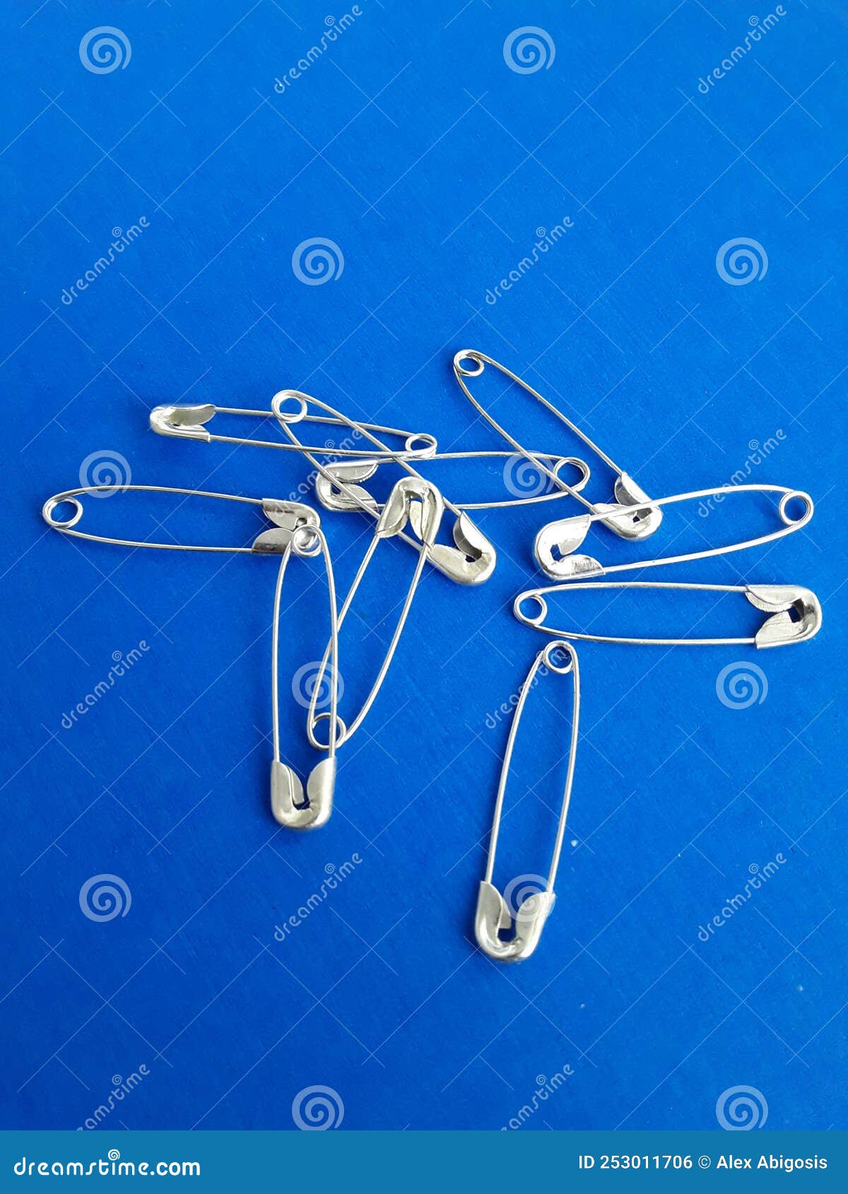 Safety Pins on a Blue Background Stock Photo - Image of blue, metal ...