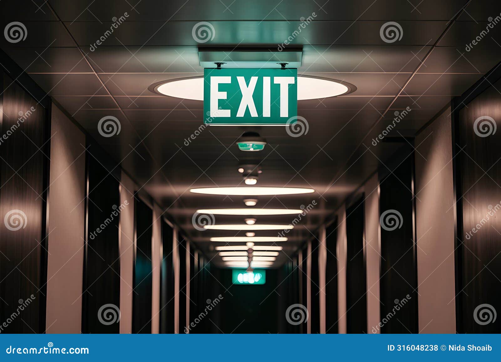 Safety Sign Indicating Emergency Exit Location in Corridor with ...