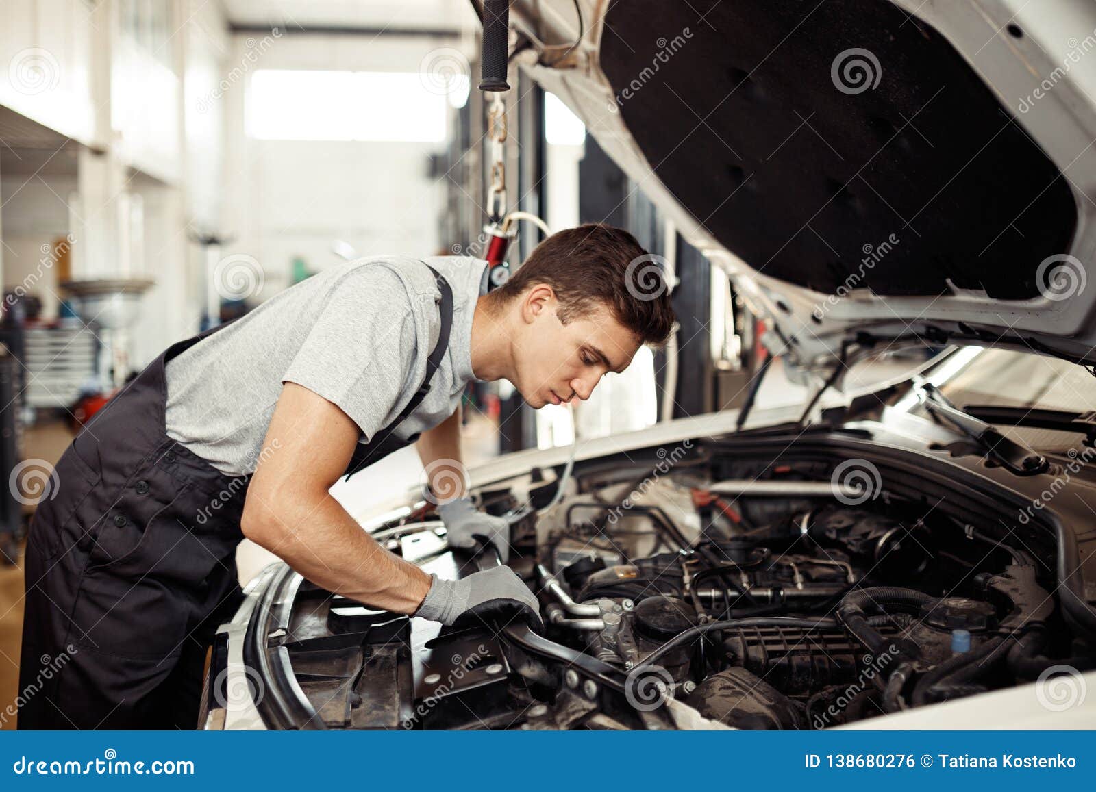 Safety Sirst: a Good-looking Car Mechanic is Checking the Engine Stock ...