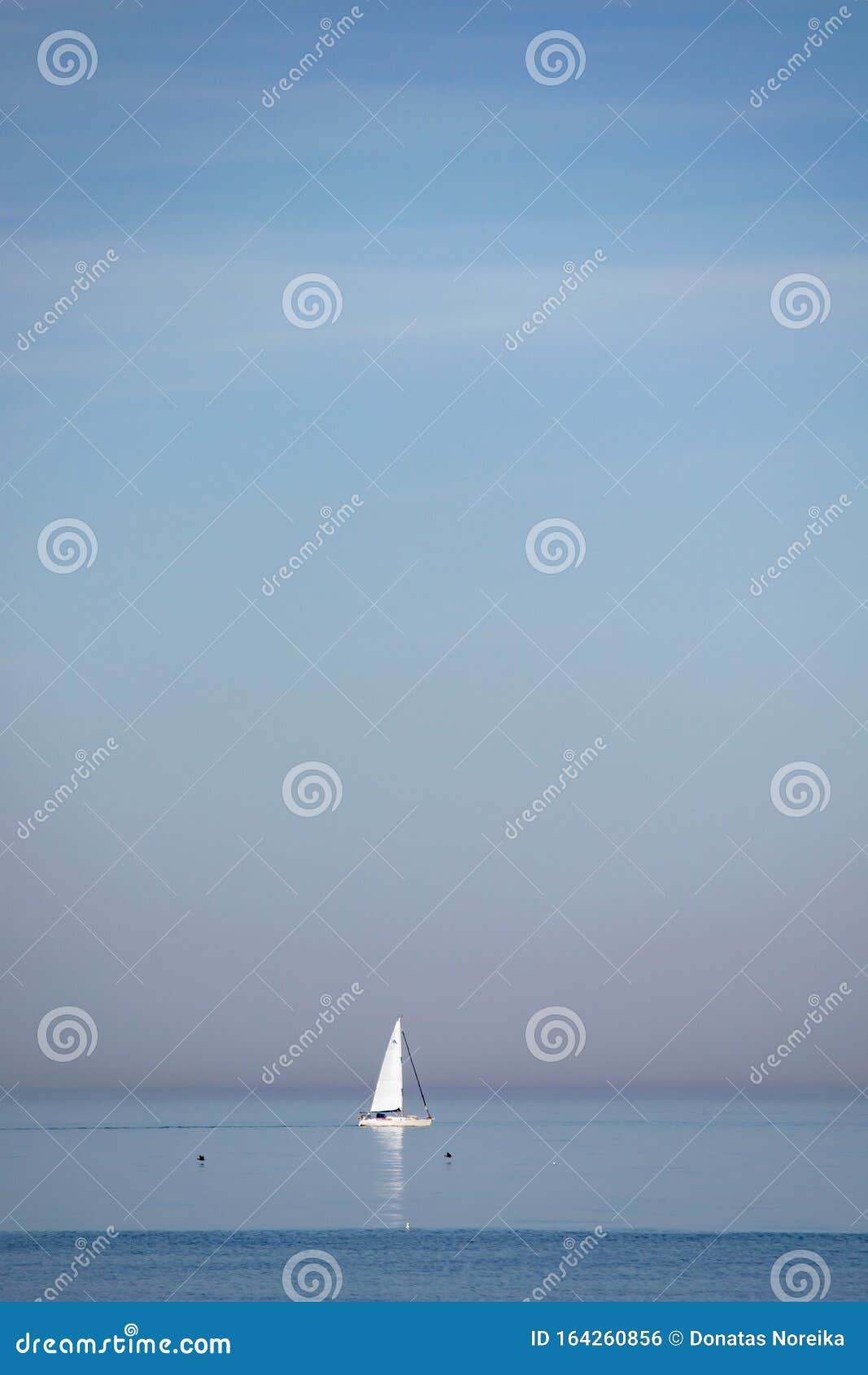 Sailboat on calm empty sea stock photo. Image of trip - 164260856
