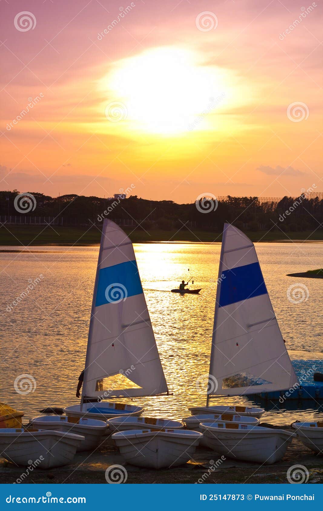 Sailboat and Canoeing in a Beautiful Lake at Sunset Stock Image - Image ...