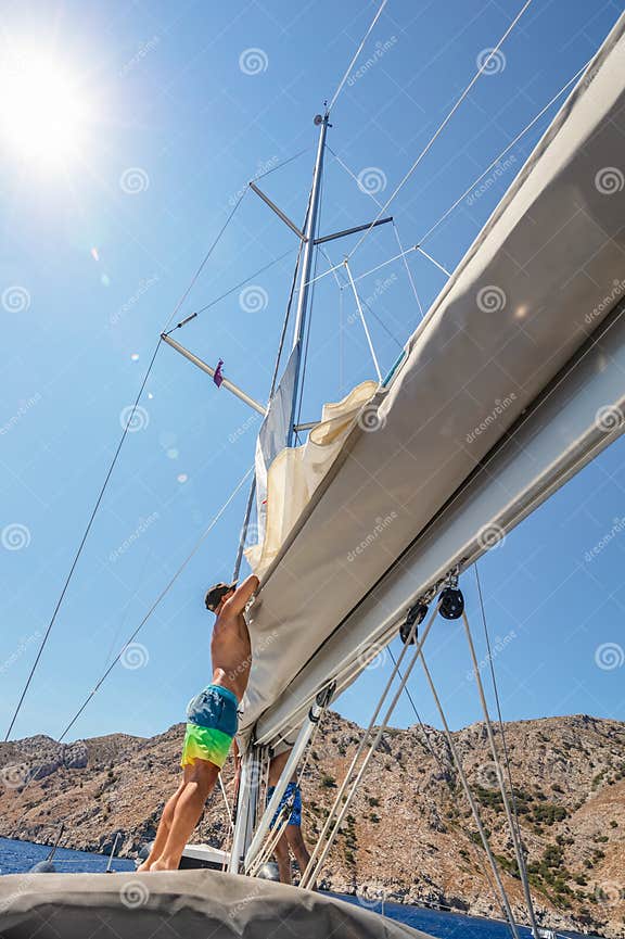 Sailboat Crew Folding the Sail Stock Image - Image of holiday, regatta ...