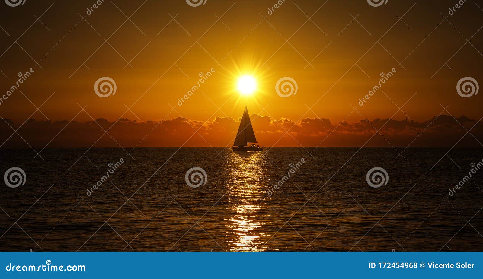 A Sailboat Sailing with the Sunrise Sun Stock Photo - Image of orange ...