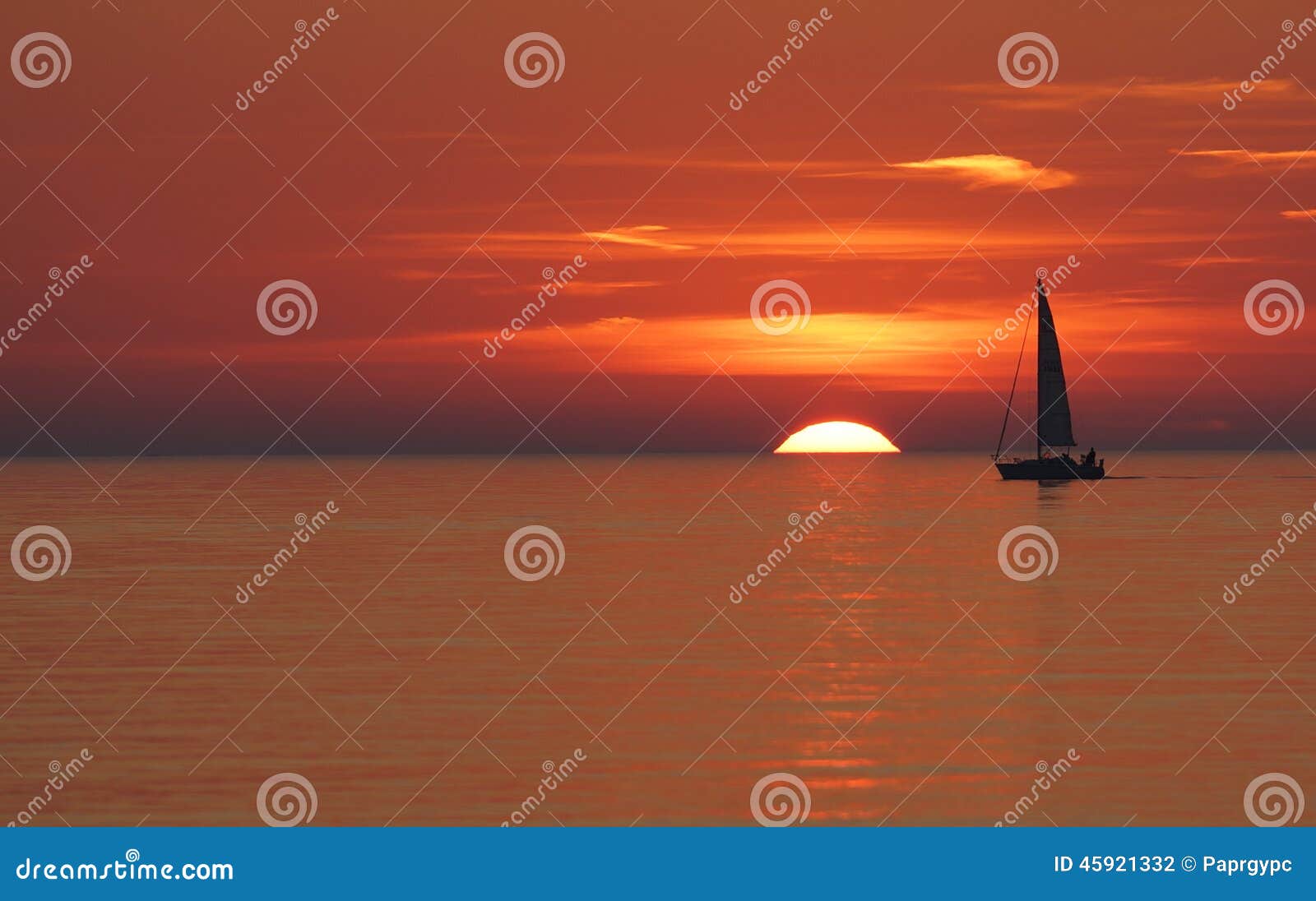 Sailboat Sailing into the Sunset Stock Photo - Image of water, sunsets ...