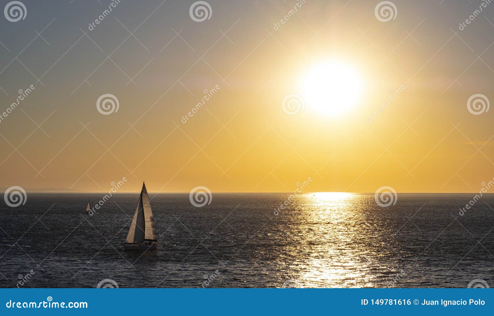 Sailboat in the Sea with Orange Light of the Sun at Sunset Stock Photo ...