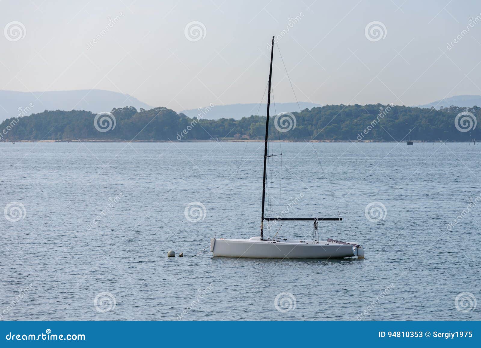 Sailing Boat with Deflated Sails Moored Near the Shore Stock Image ...
