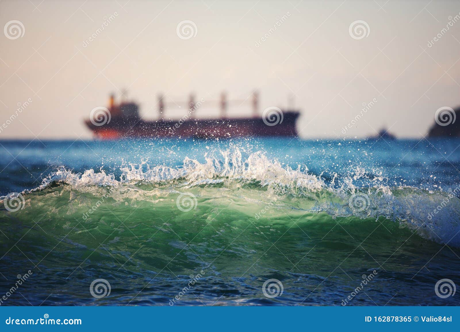Sailing Cargo Ship and Waves at Sunrise. Transportation. Logistics ...