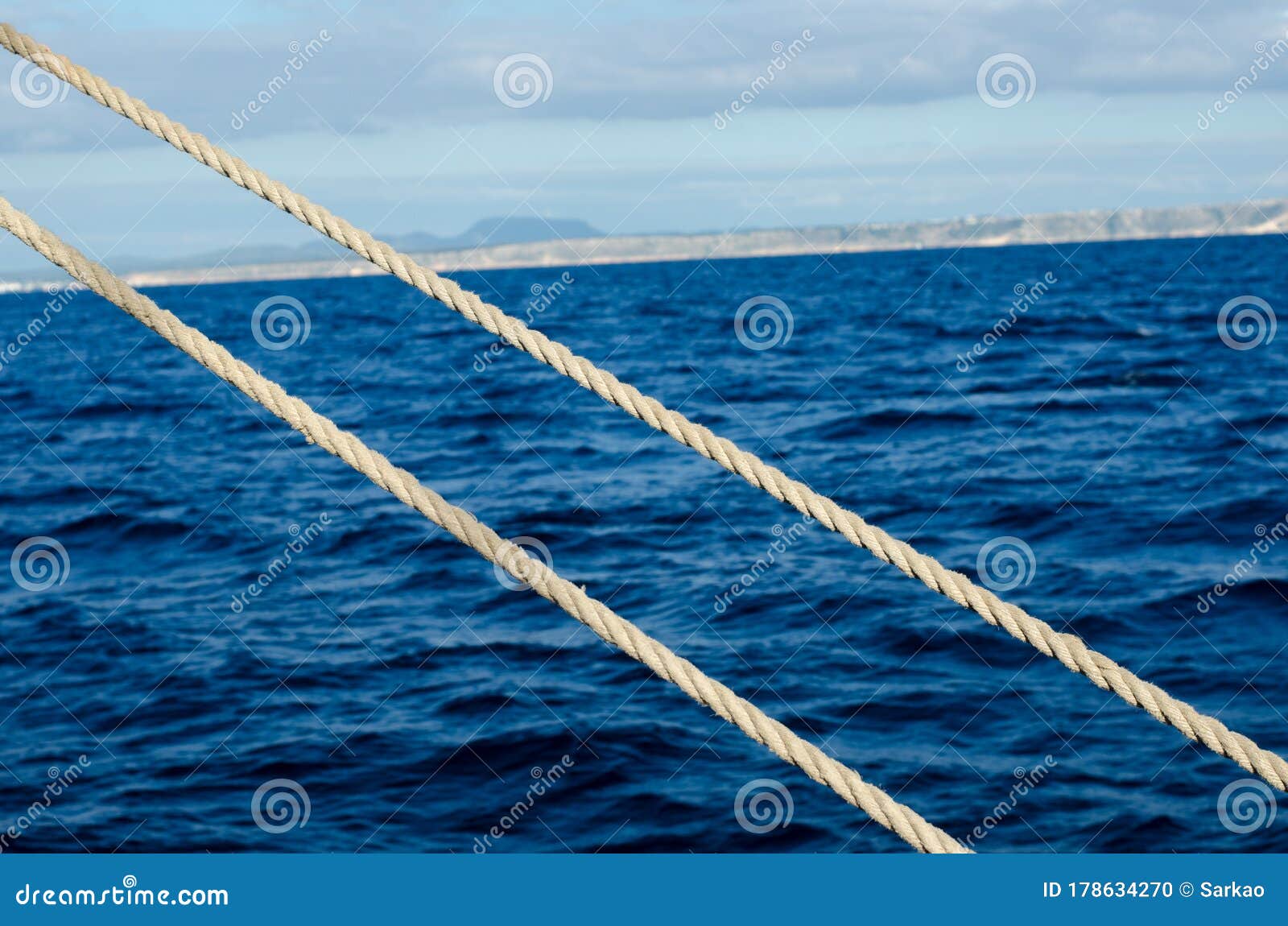 Sailing rope and blue sea stock photo. Image of detail - 178634270