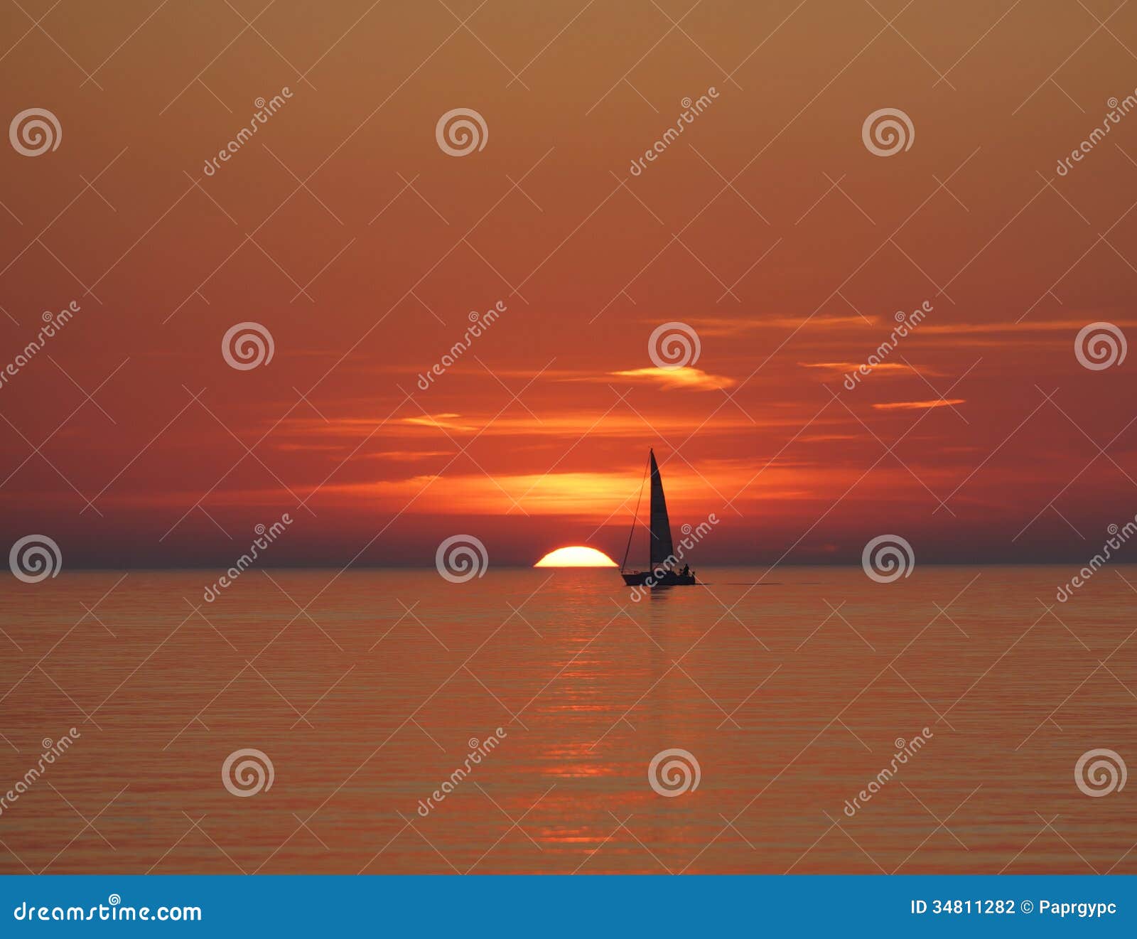 Sailboat Sailing into the Sunset Stock Photo - Image of sailboats ...