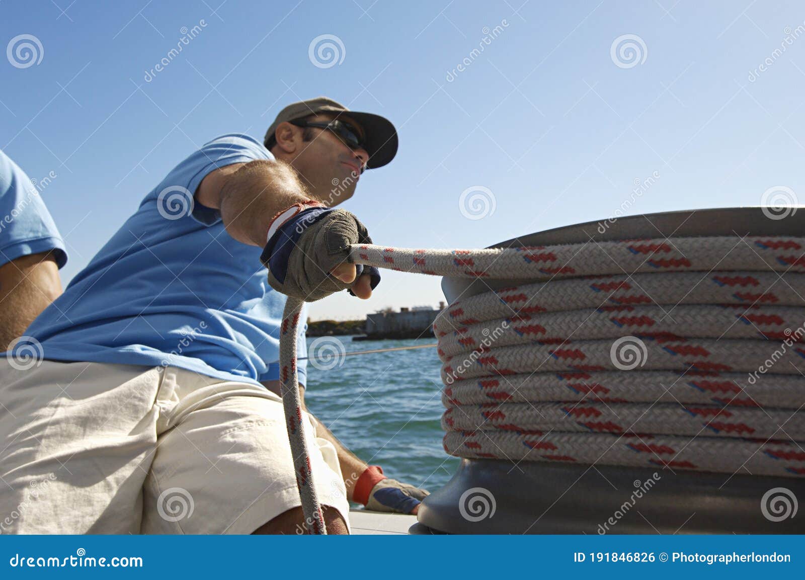 Sailor Adjusting Rope on Boat Stock Photo - Image of sailor, boating ...