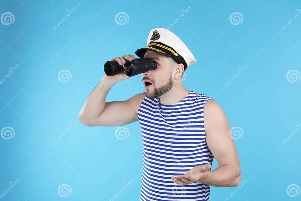 Sailor Looking through Binoculars on Light Blue Background Stock Photo ...
