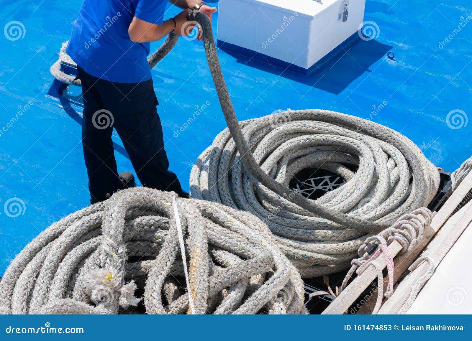 Sailor on the Ship is Giving Mooring in the Port. the Rope is Coiling ...