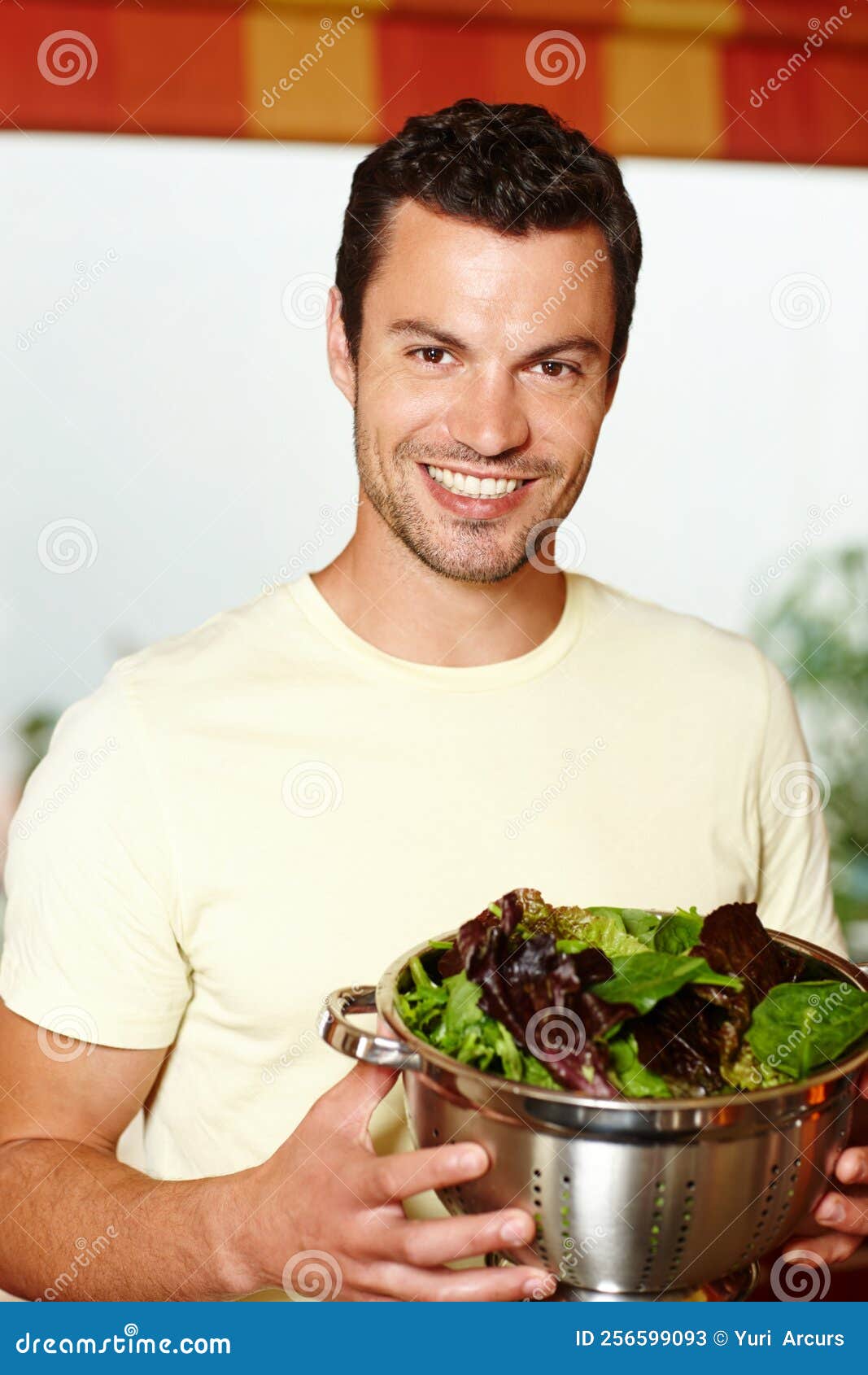 Salad for You. a Man Standing in the Kitchen Holding a Bowl of Lettuce ...
