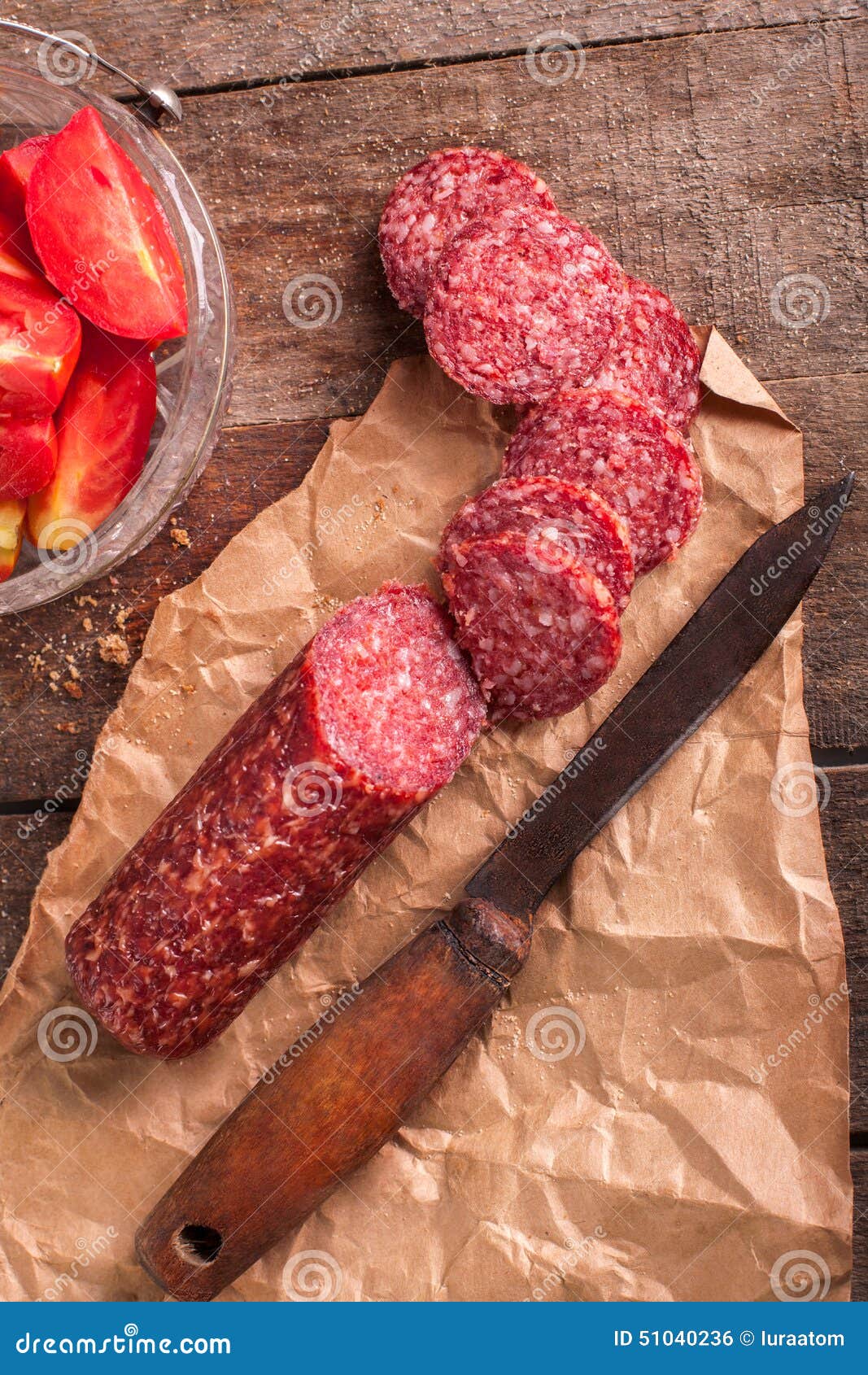 Salami on a Paper with Tomato Stock Photo - Image of wood, table: 51040236