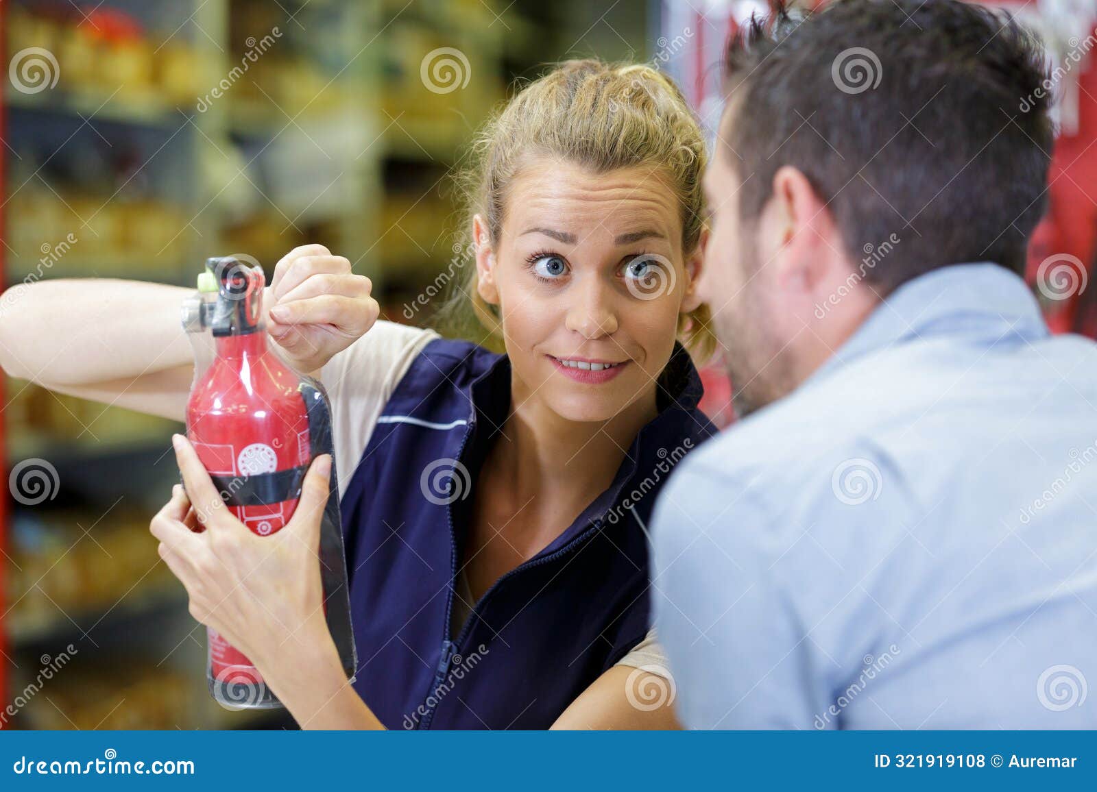 Sales Assistant with Customer Holding Fire Extinguisher Stock Photo ...