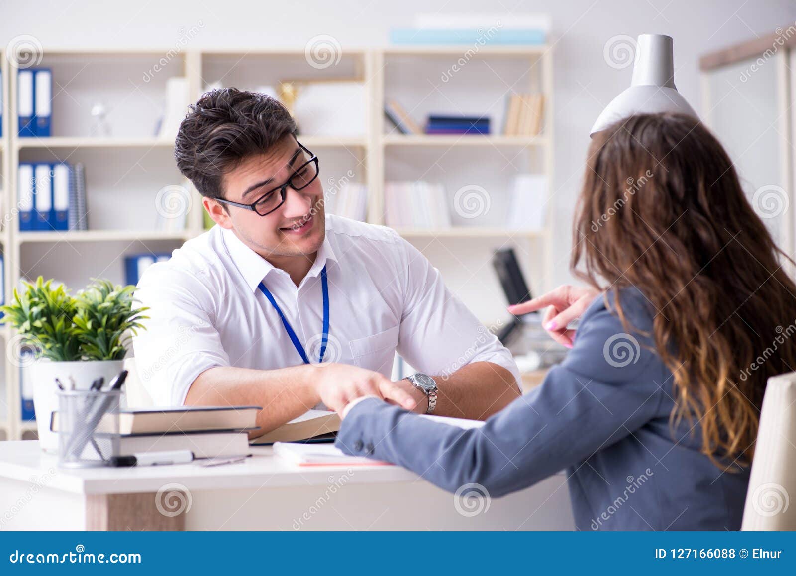 The Sales Assistant Discussing Transaction with Customer Stock Photo ...