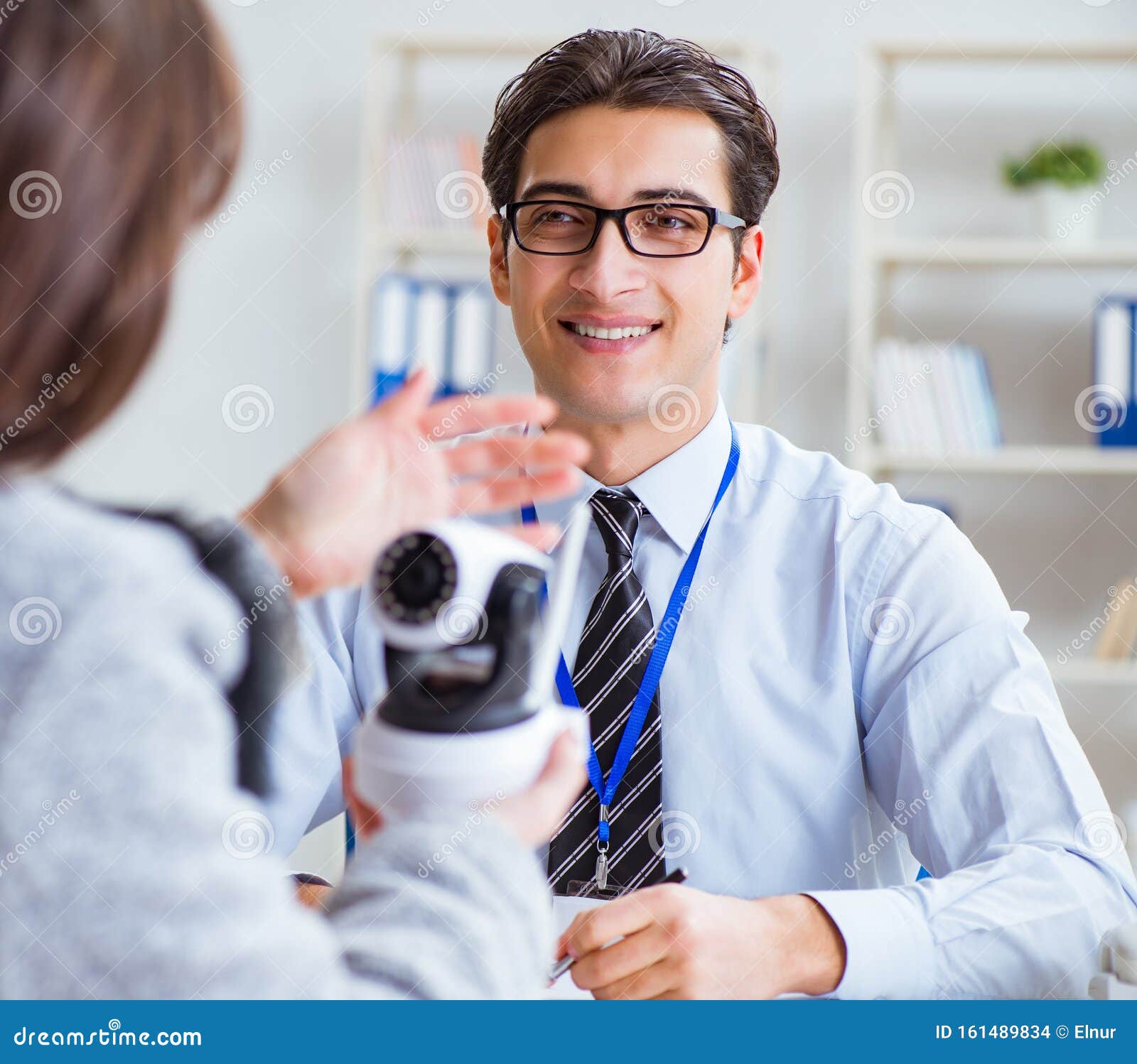 Sales Assistant Showing Cameras To Client in Shop Stock Photo - Image ...