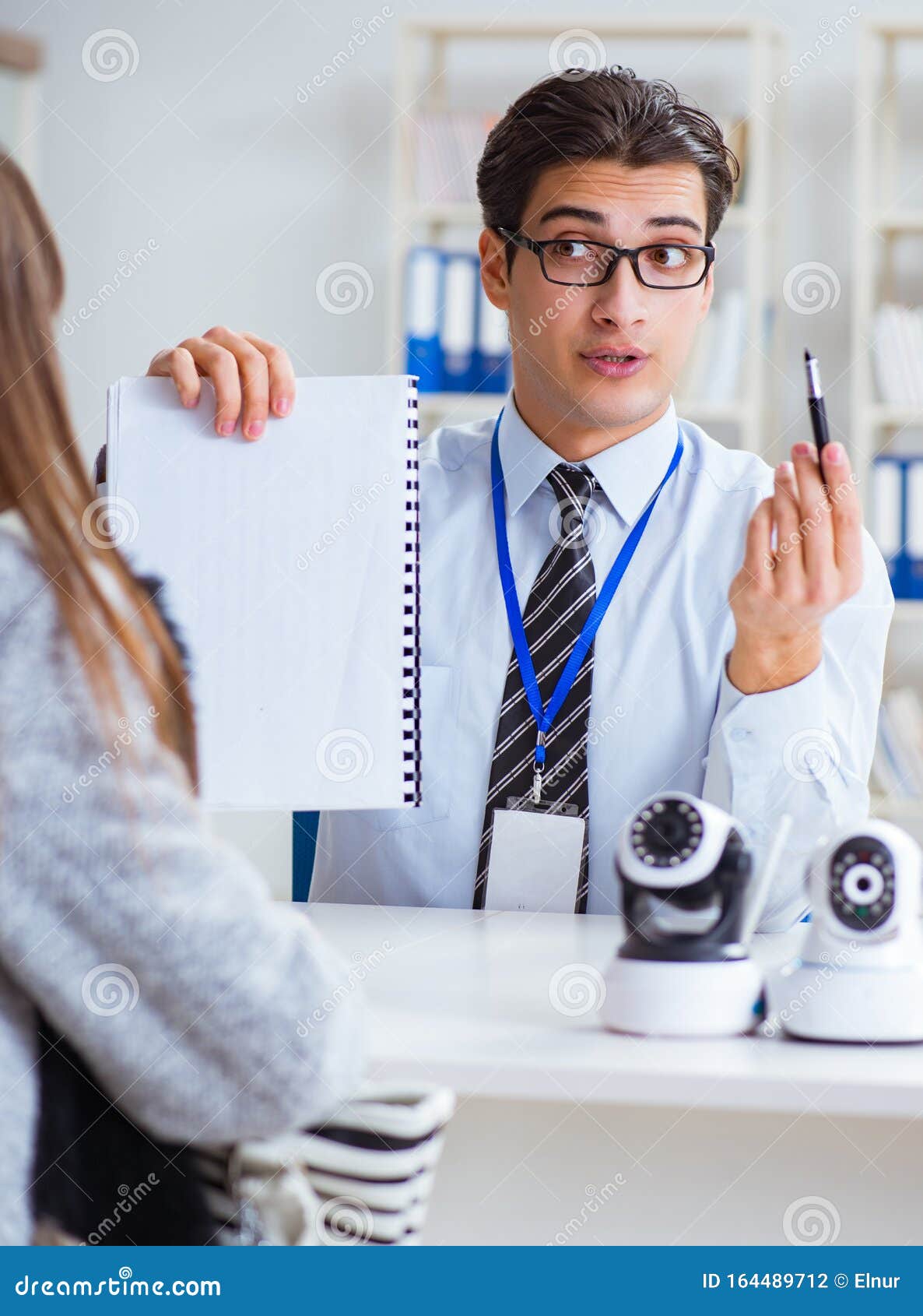 Sales Assistant Showing Cameras To Client in Shop Stock Photo - Image ...