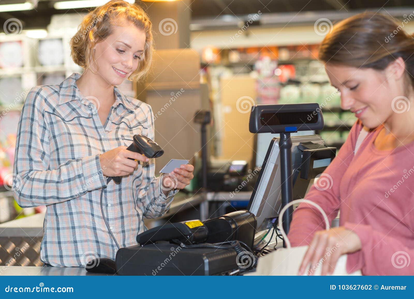 Sales Assistant Working at Check-out Stock Photo - Image of scannning ...