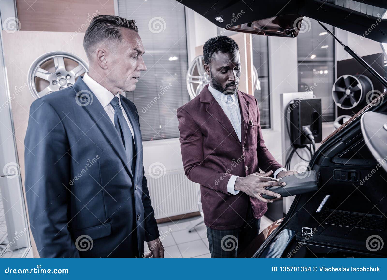 Sales Manager Opening Trunk Showing His Client Everything about Car ...