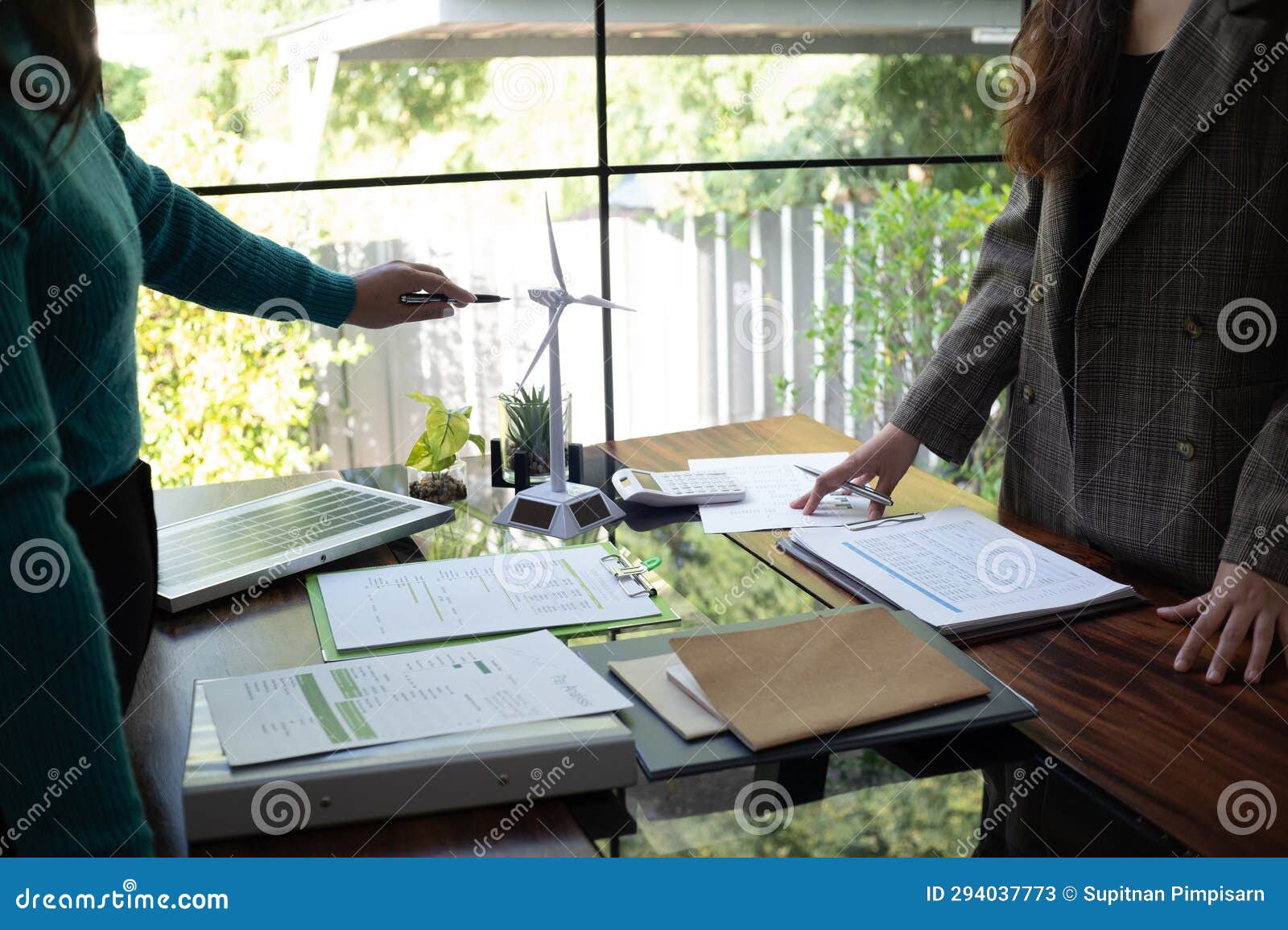 A Sales Representative Presenting Solar and Wind Power, Alternative ...