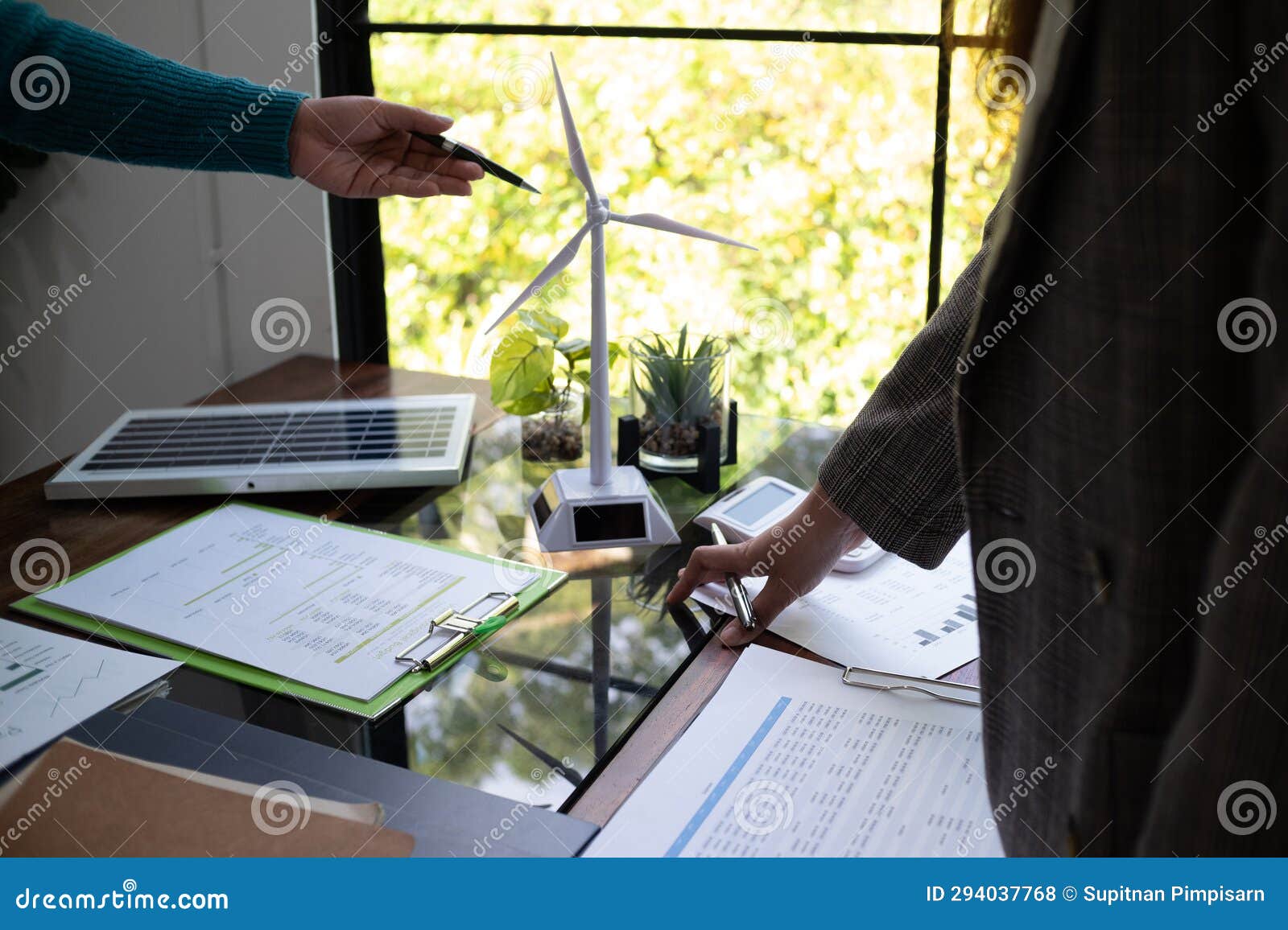 A Sales Representative Presenting Solar and Wind Power, Alternative ...