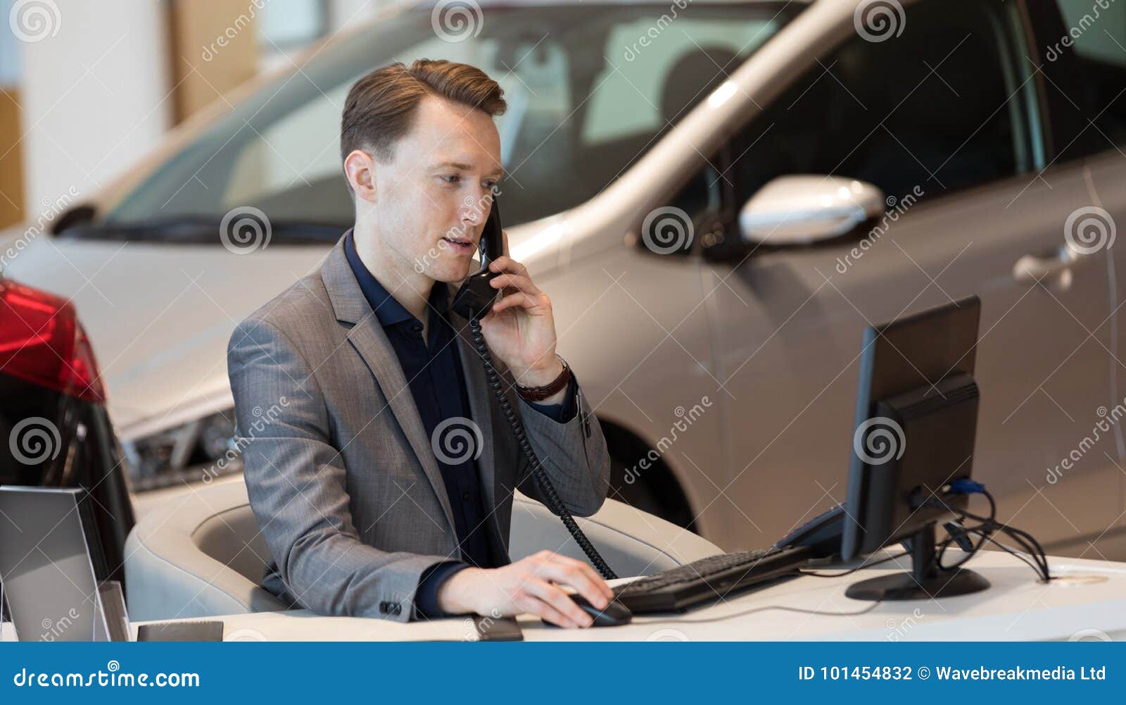 Sales Talking on Phone while Using Computer Stock Photo - Image of male ...