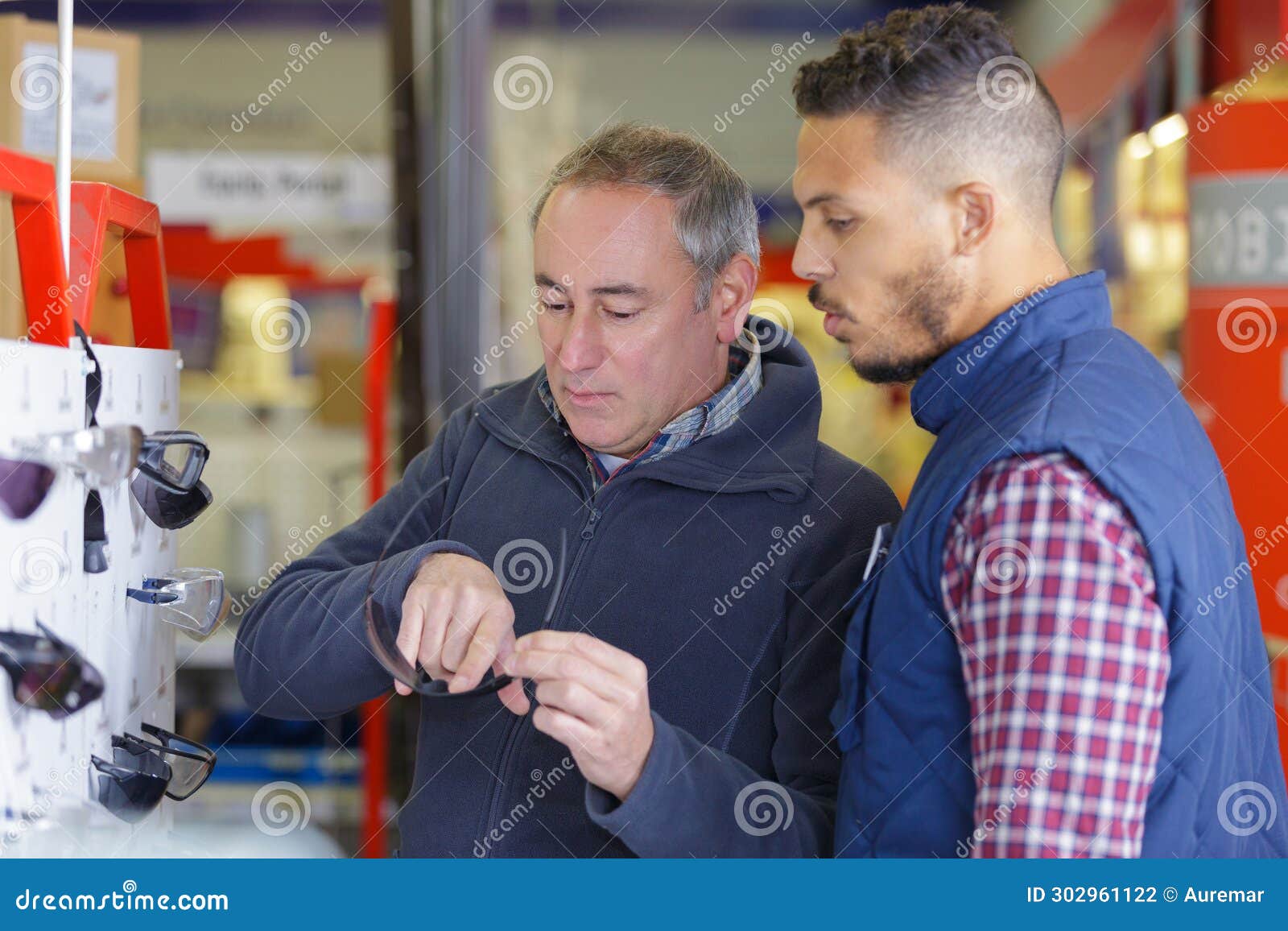 Salesman Assisting Customer in Buying Product at Hardware Store Stock ...