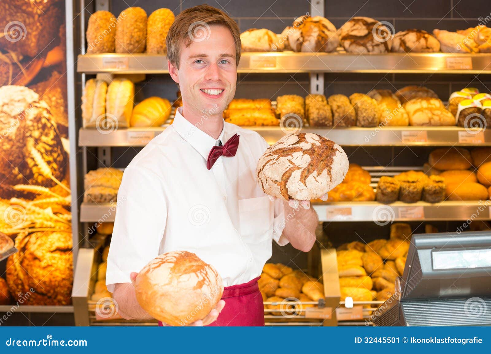 Salesman in Bakery Holding Different Types of Bread Stock Image - Image ...