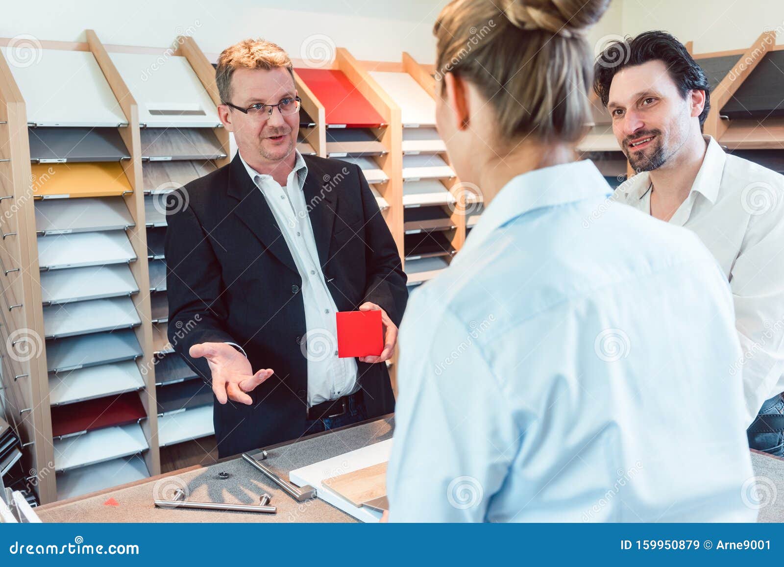 Salesman Explaining Options for Colors and Materials of New Kitchen ...