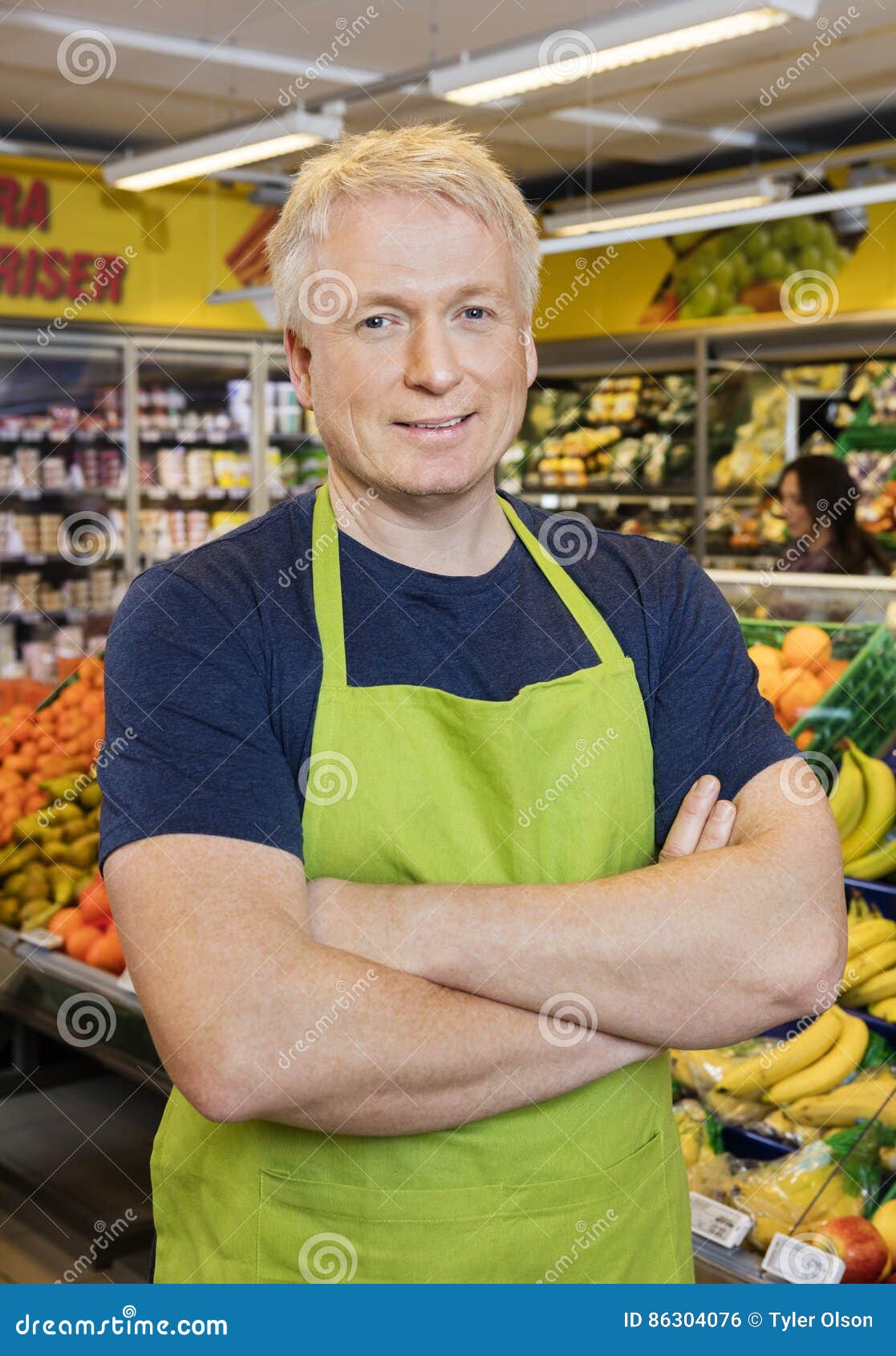 Salesman with Hands Folded Standing in Grocery Store Stock Photo ...