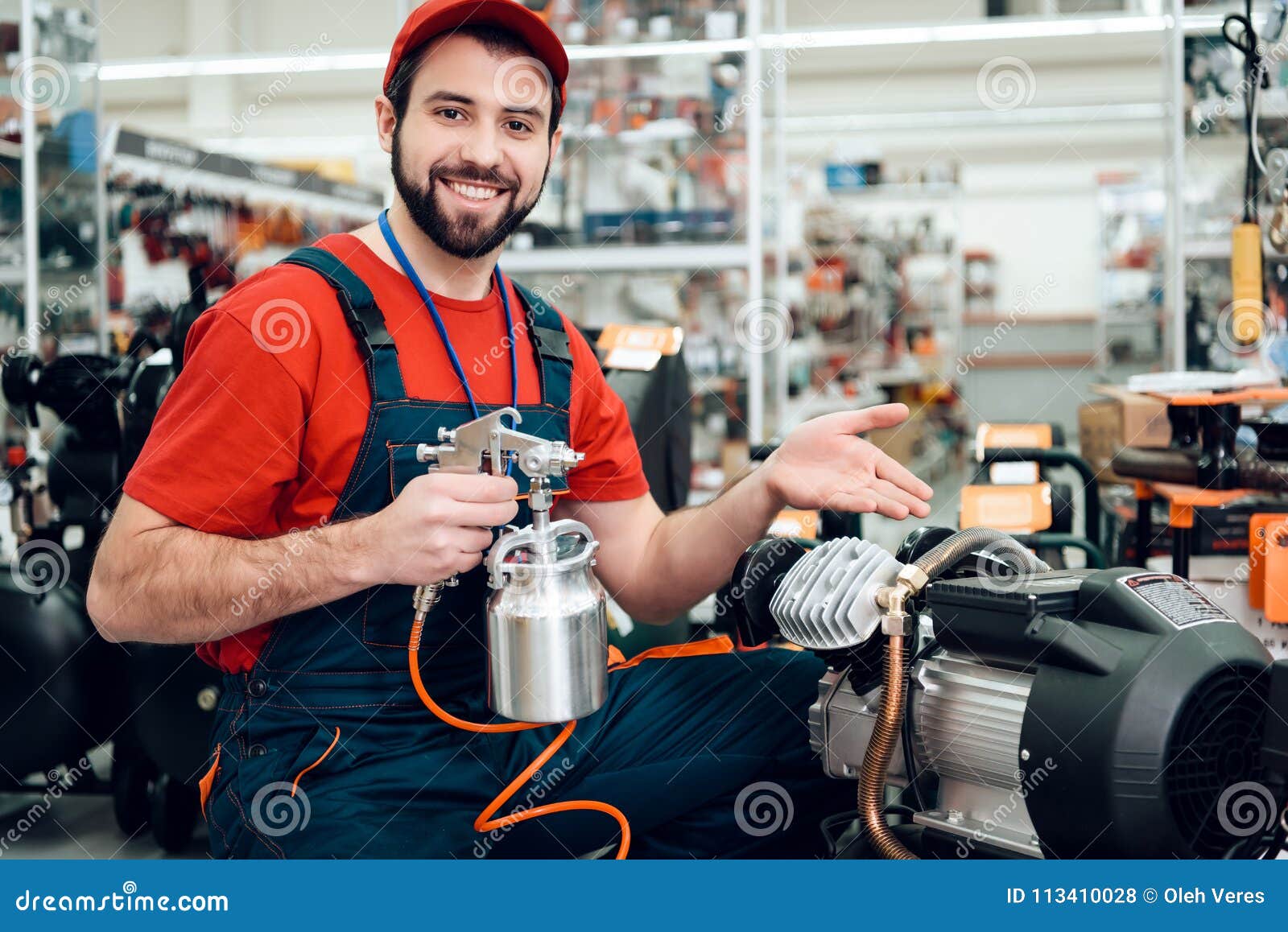 Salesman is Posing with Compressor Paint Sprayer on Foreground in Power ...