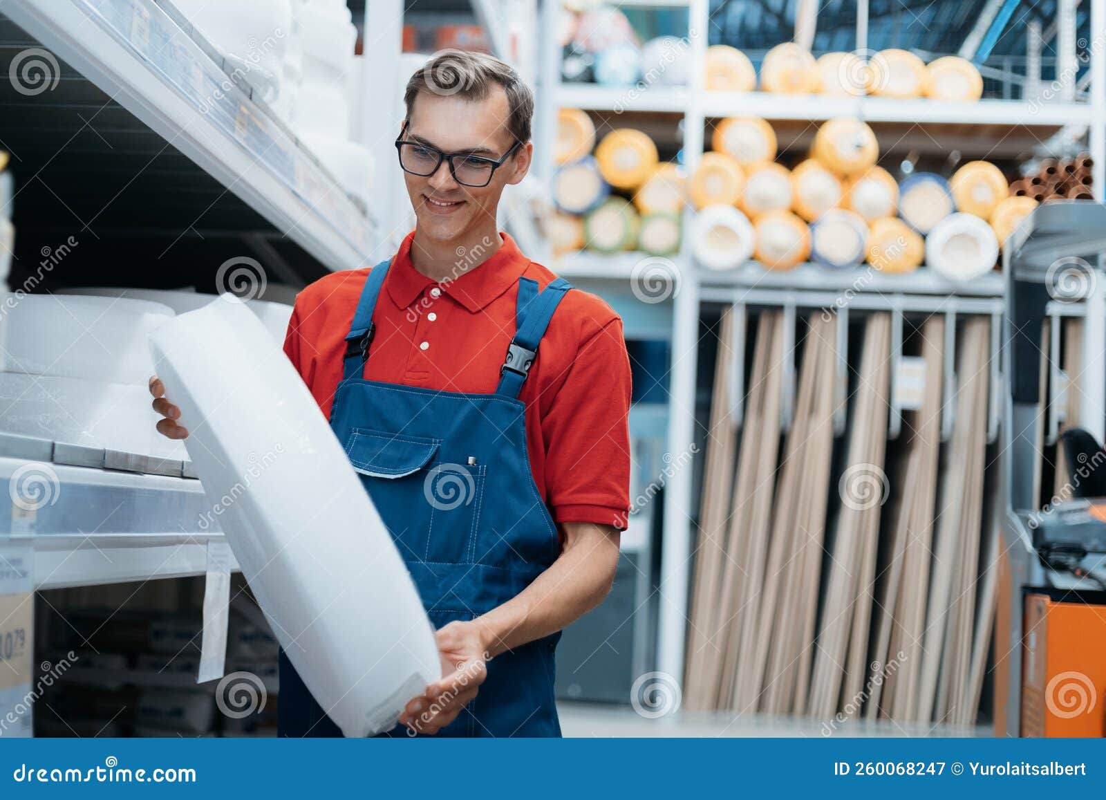 Salesman with a Roll of Insulation in His Hands Standing in a Hardware ...