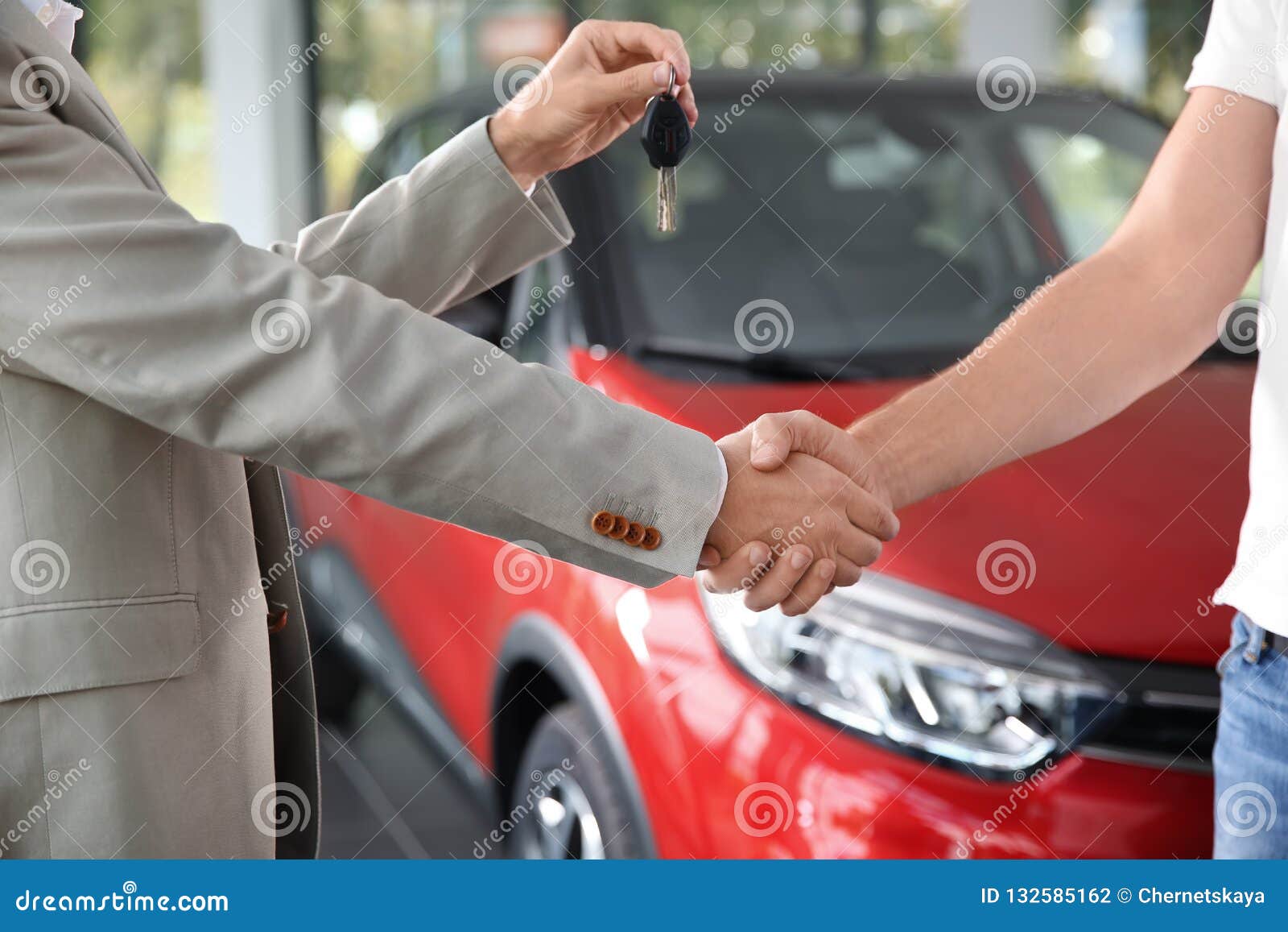 Salesman Shaking Hands with Customer while Giving Car Key in Auto ... Salesman Shaking Hands with Customer while Giving Car Key in Auto ...