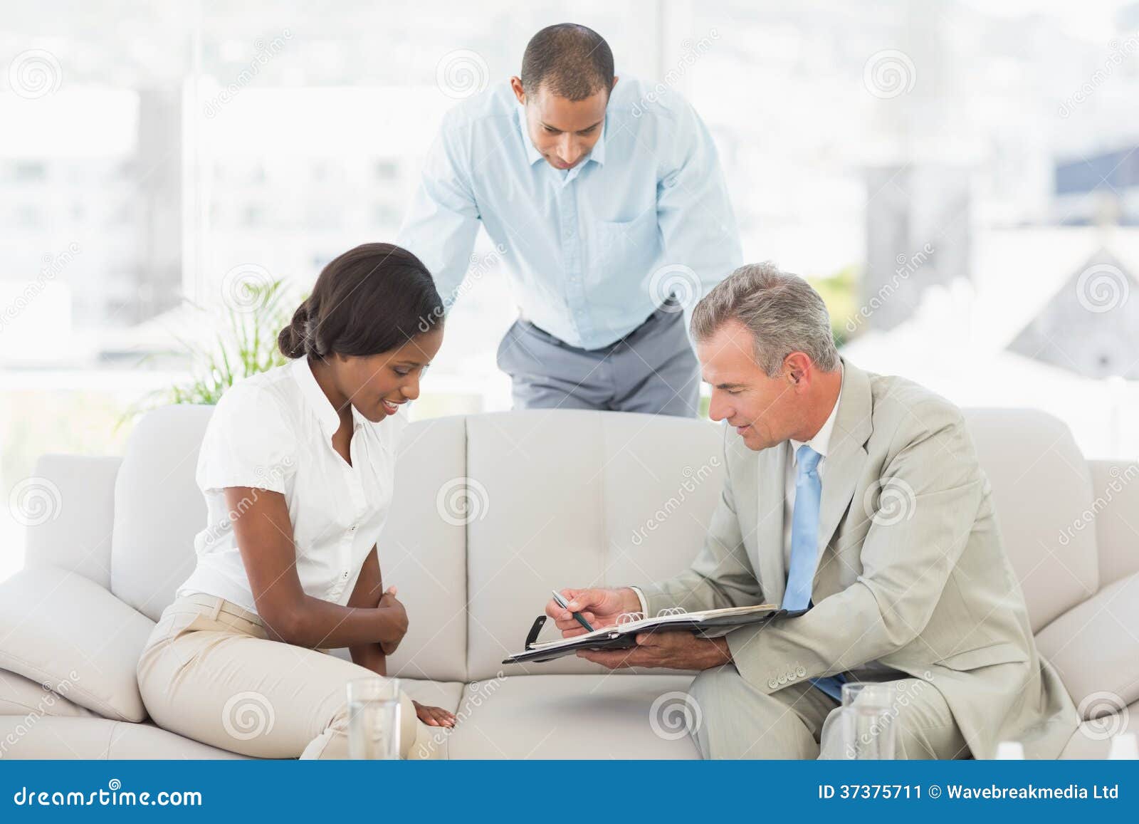 Salesman Showing Client Where To Sign the Paperwork Stock Image - Image ...