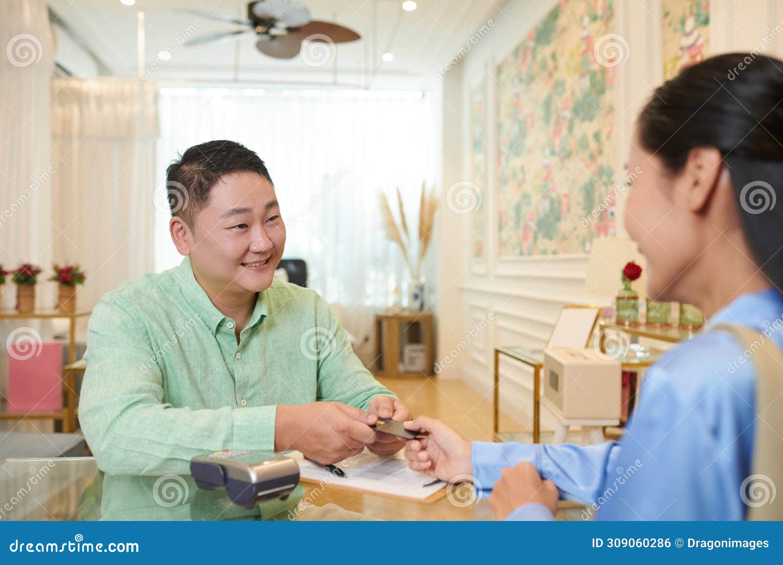 Salon Receptionist Accepting Payment Stock Photo - Image of korean ...