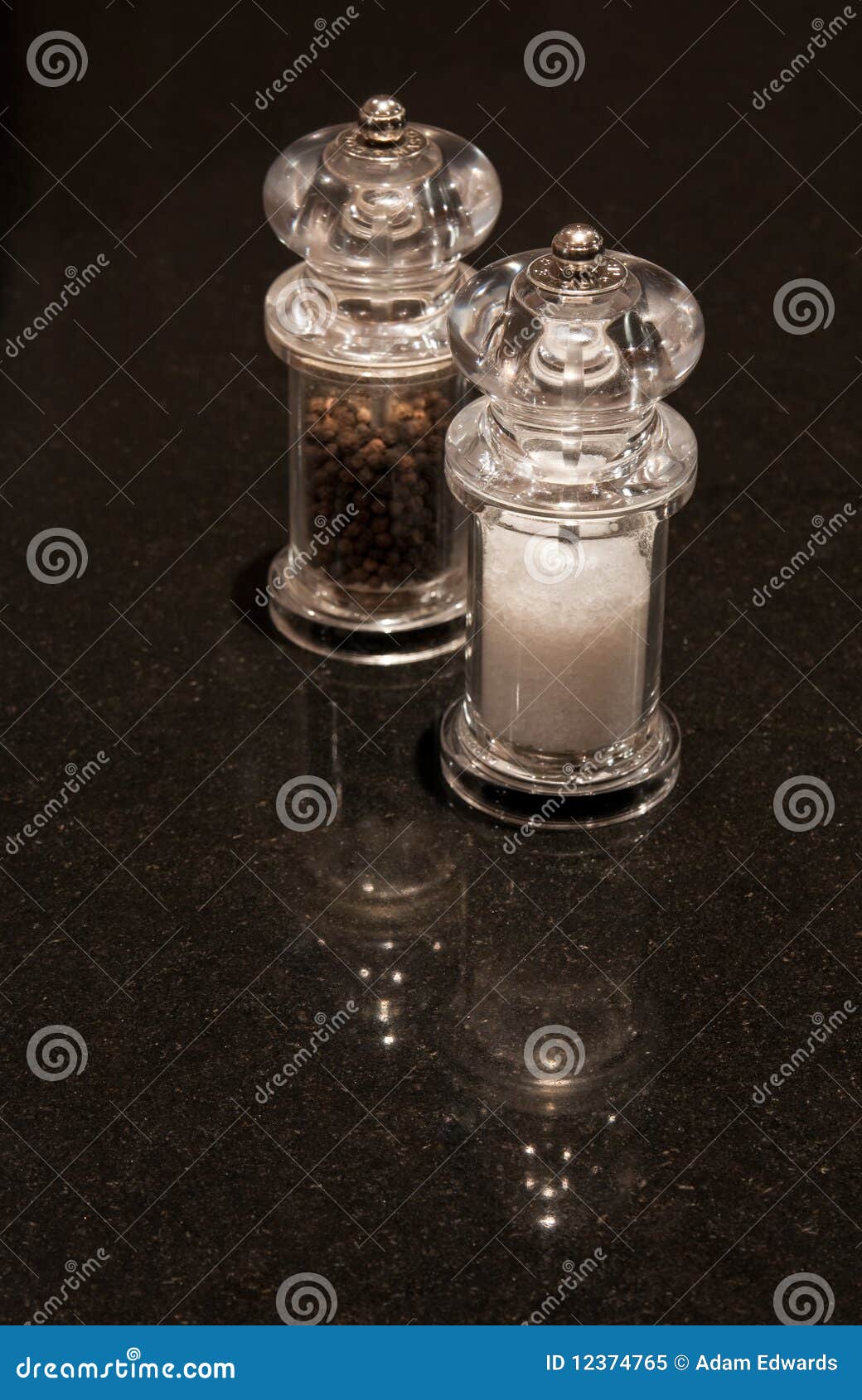Salt and Pepper Shakers on a Dark Background Stock Image - Image of ...