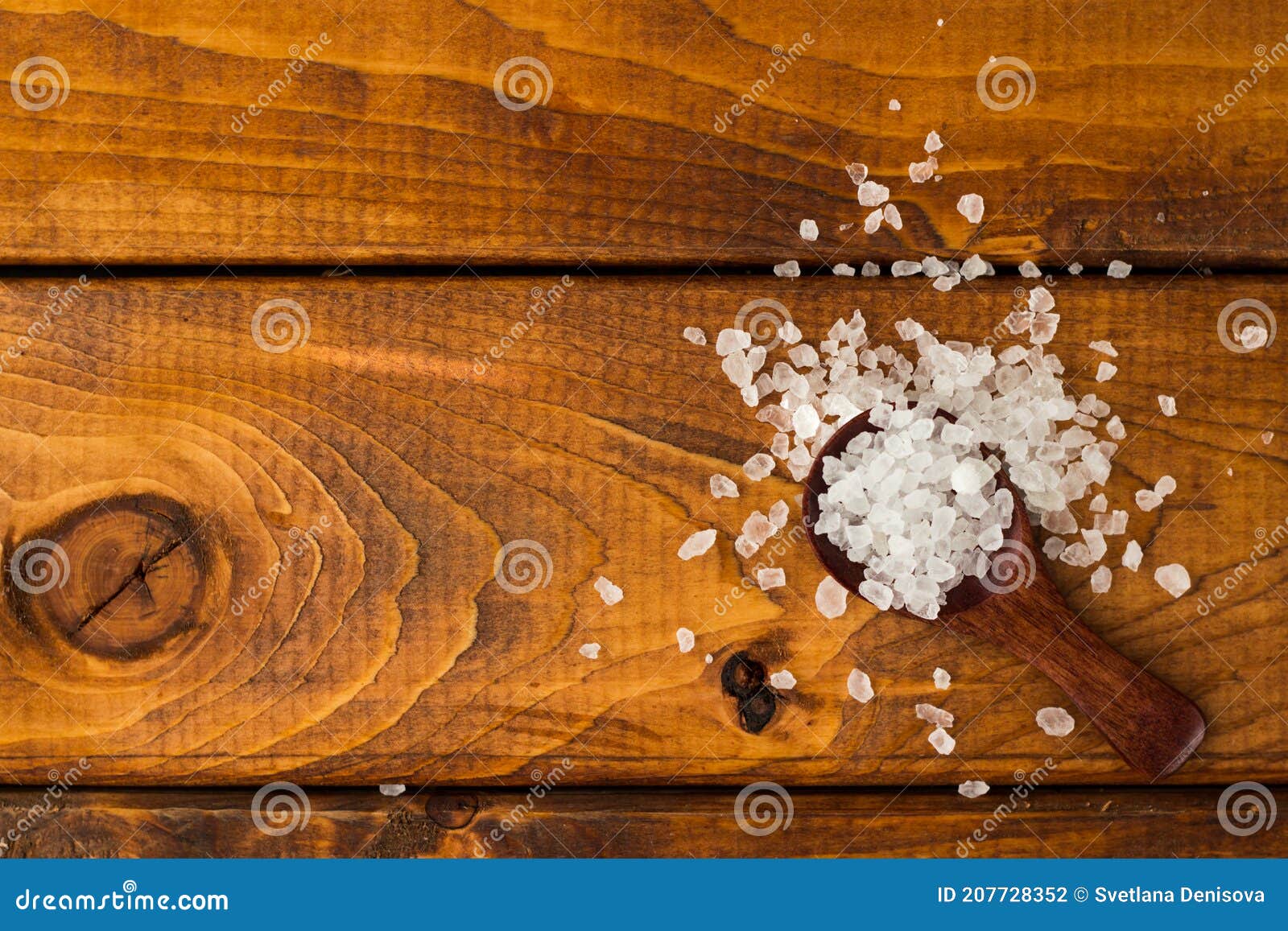 Salt in a Wooden Spoon on a Wooden Table. Large Pieces of Salt in a ...