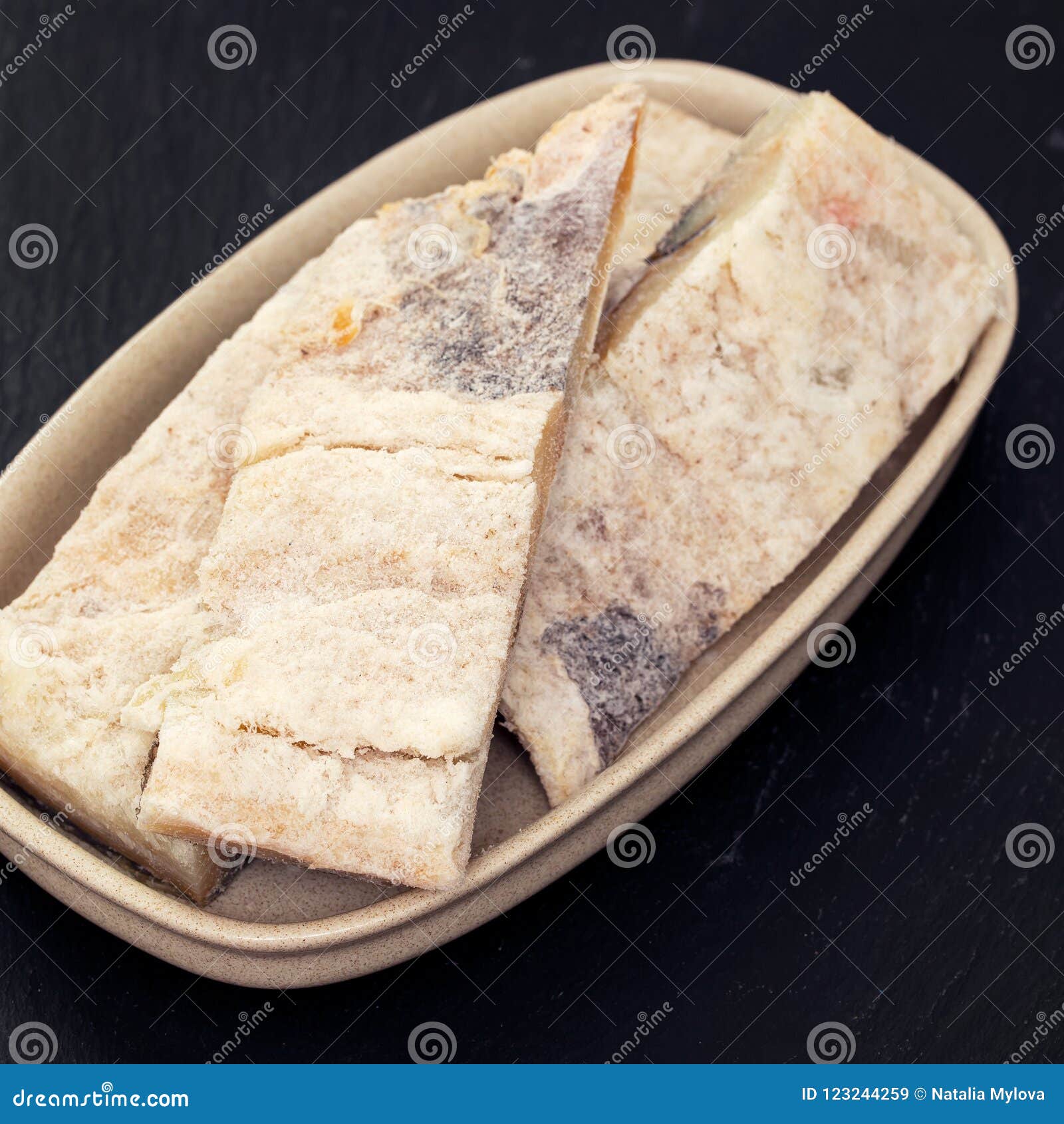 Salted Dry Cod Fish On Black Ceramic Background Stock Image - Image of ...