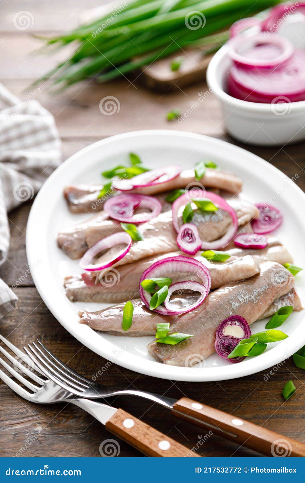 Salted, Marinated Herring Fillet with Onion on Plate Stock Photo ...