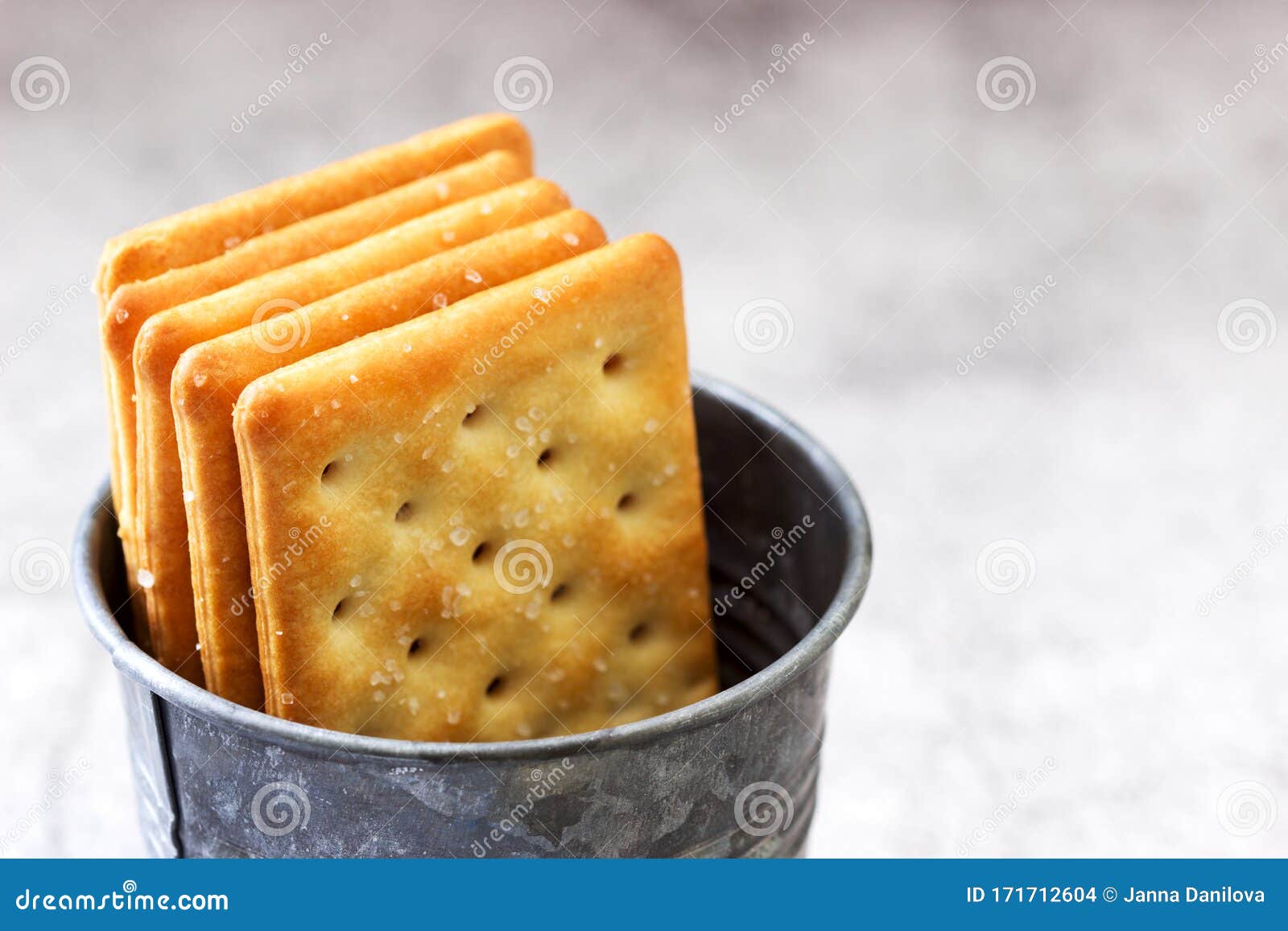 Salty Rectangular Crackers in a Galvanized Bucket on a Gray Background ...