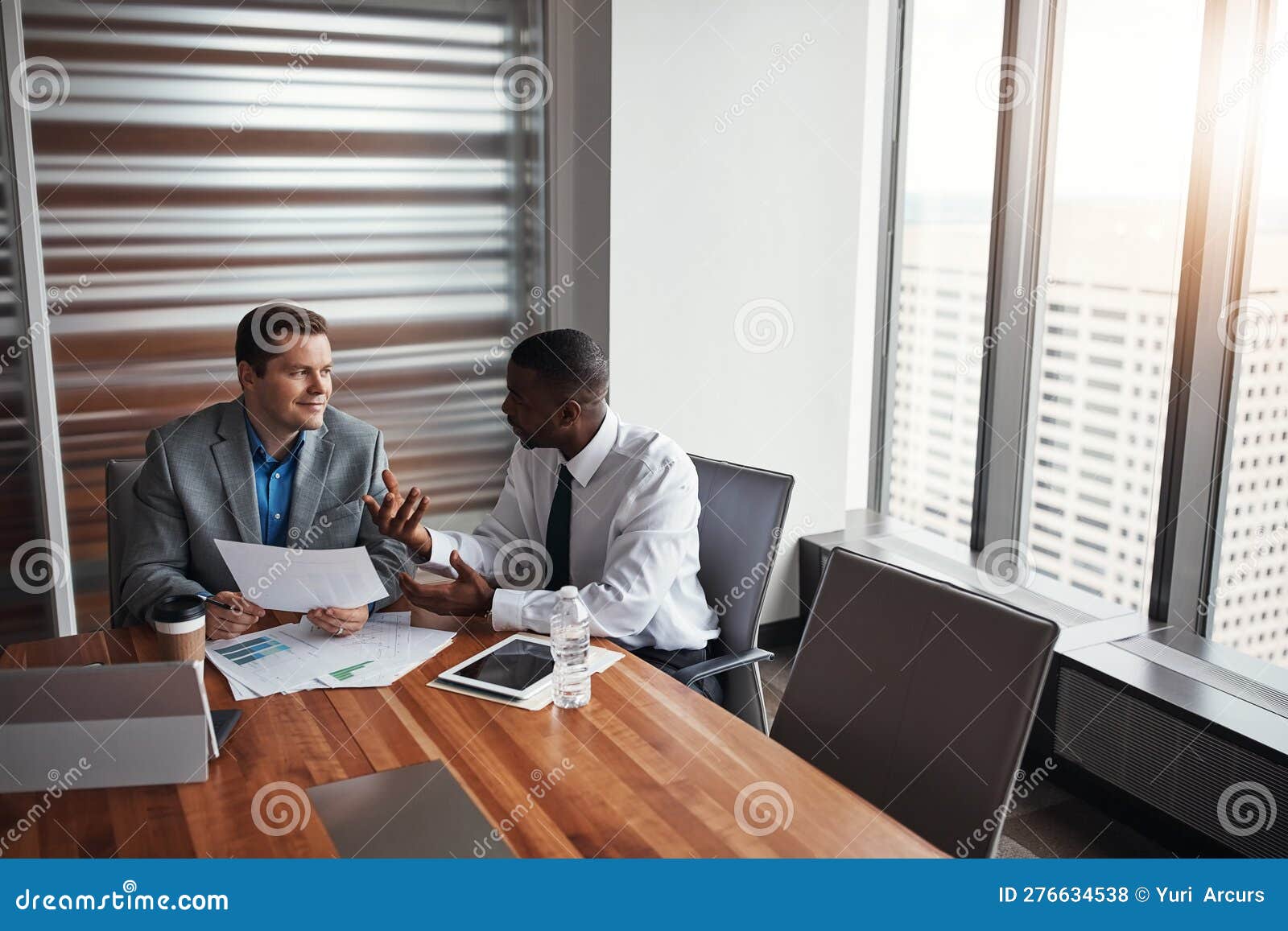 Are we on the Same Page. Two Businessmen Going through Paperwork in an ...