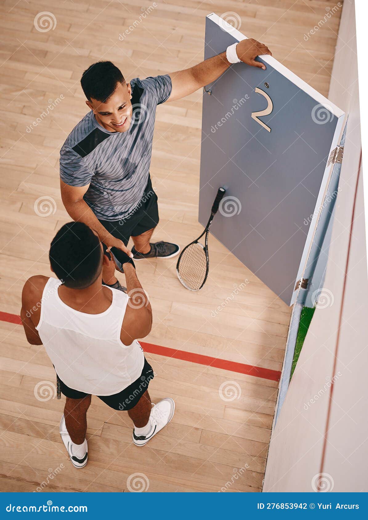 Same Time Next Weekend. High Angle Shot of Two Young Men Shaking Hands ...