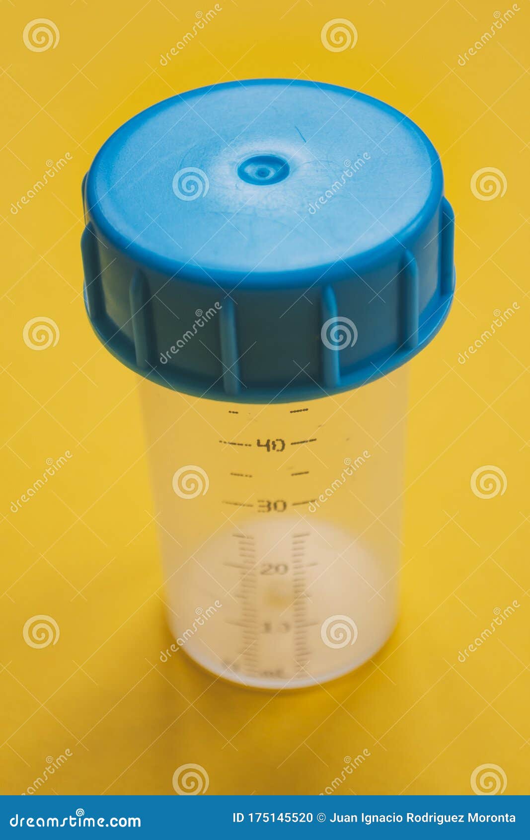 Sample Container for Medical Tests with Blue Cap on a Yellow Background ...
