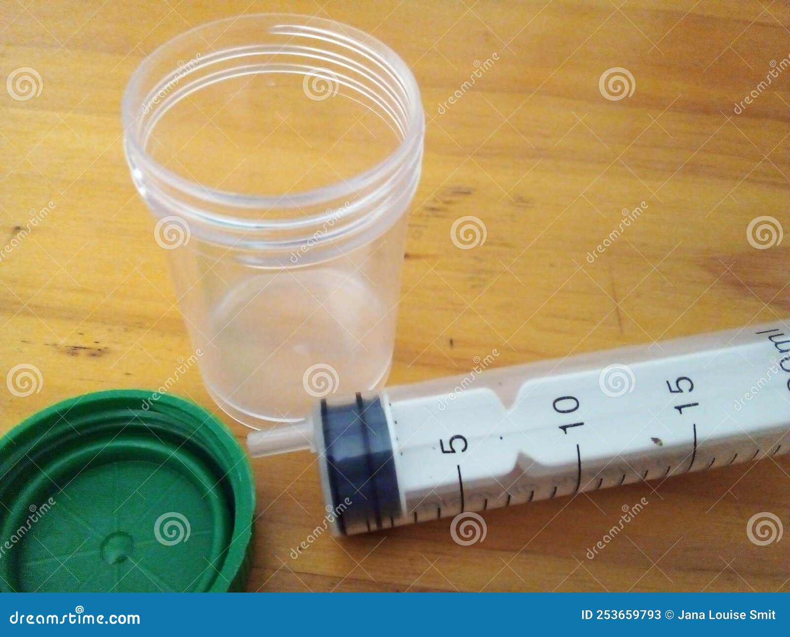 A Sample Cup and Syringe stock image. Image of liquid - 253659793