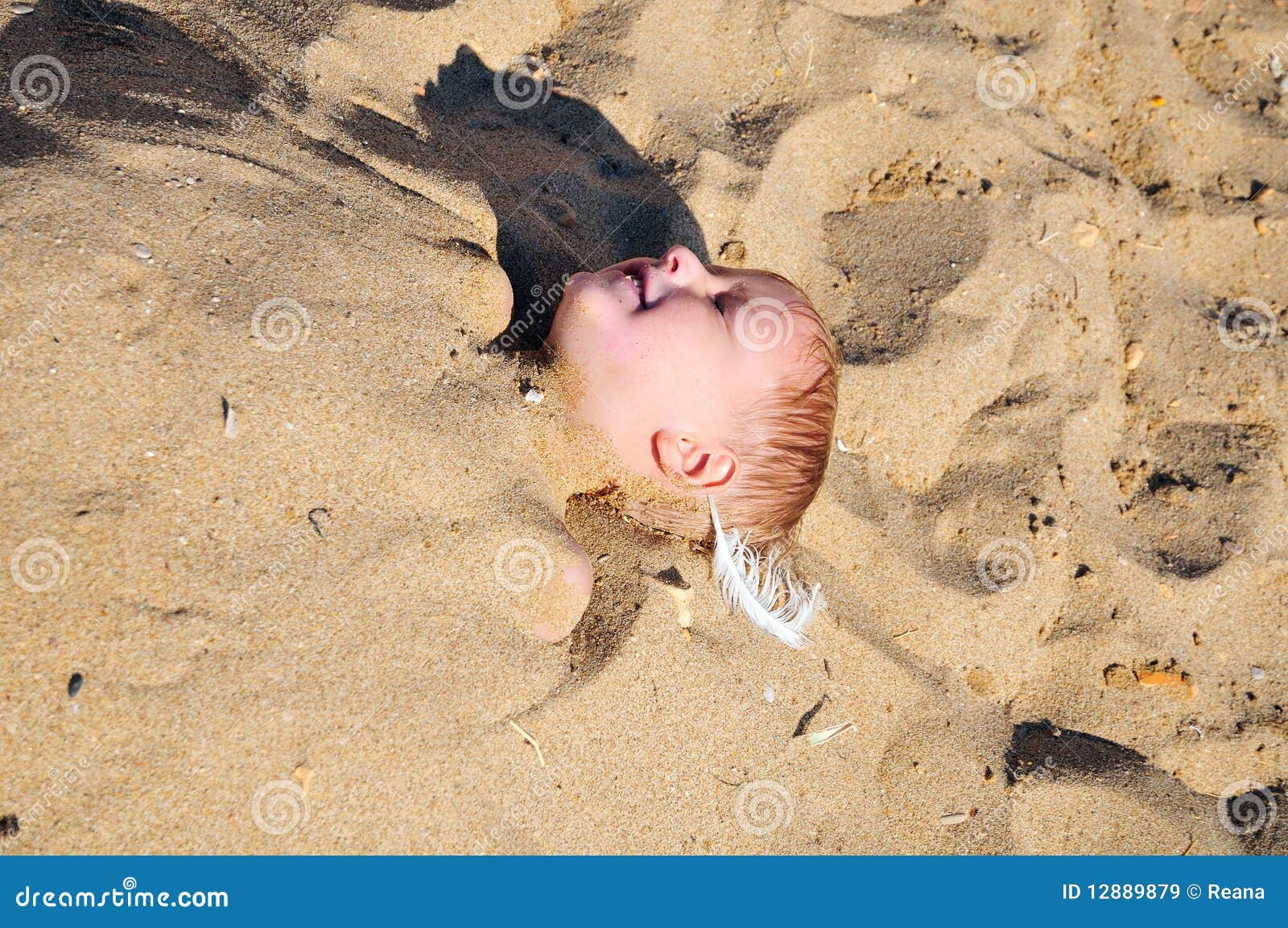 In the sand stock image. Image of play, cheerful, head - 12889879