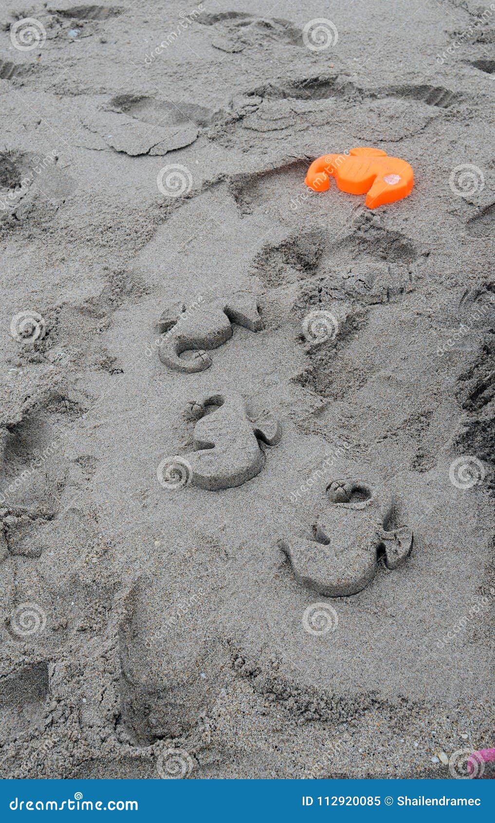 Sand art by kid at beach stock image. Image of relax - 112920085