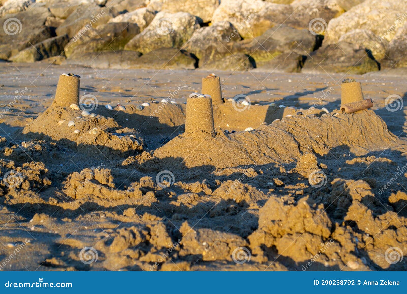 Sand Castle Decorated with Shells on the Seashore Under the Rays of the ...