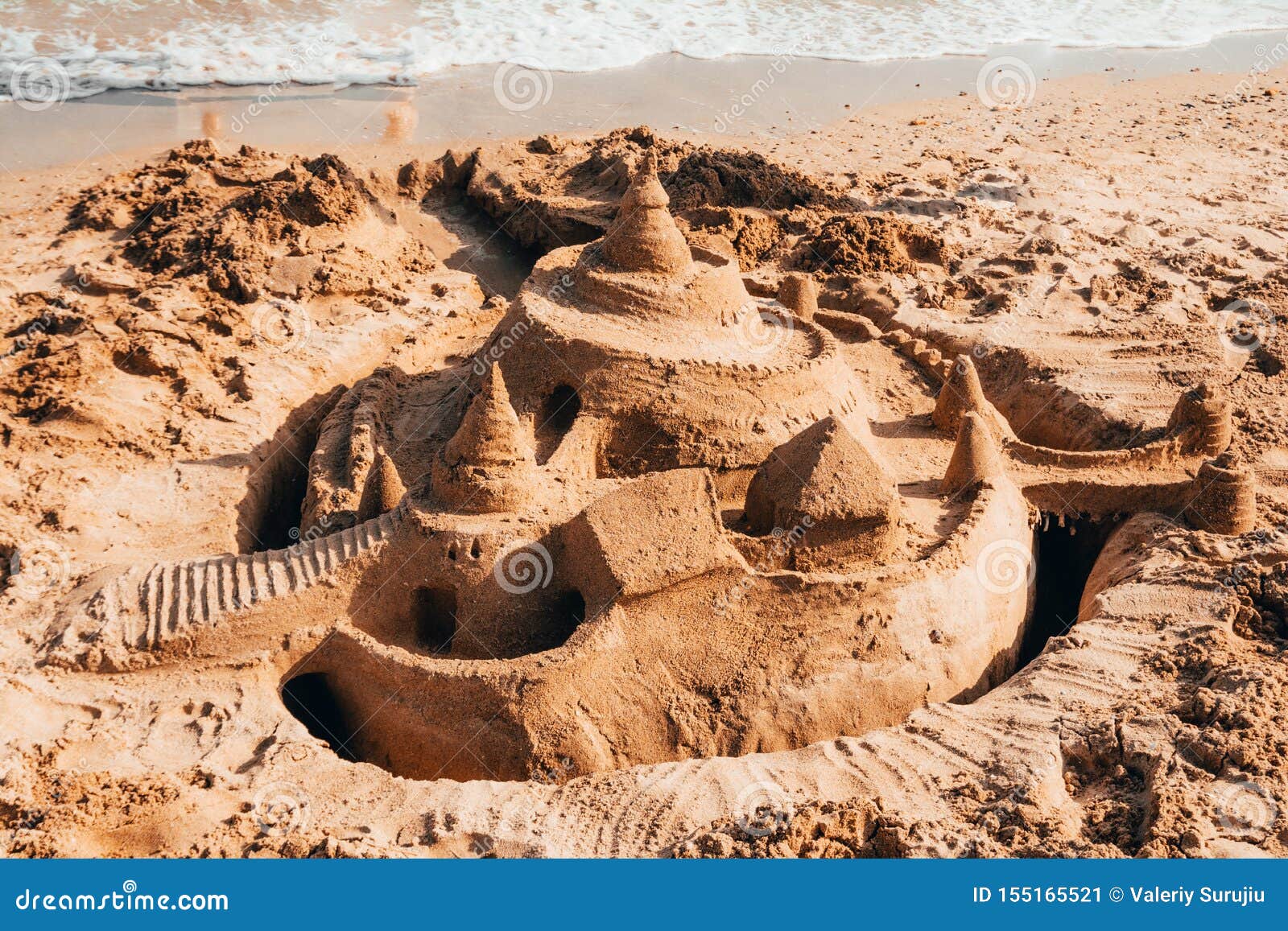Sand castle by the sea stock image. Image of creation - 155165521